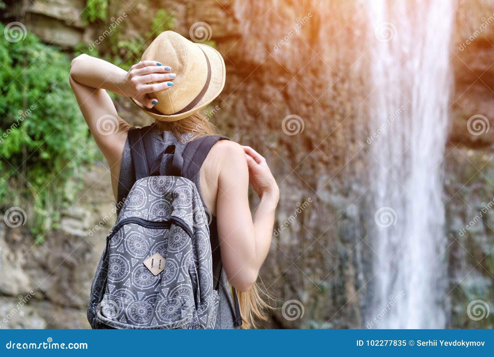 Girl in the Hat Admires the Waterfall. View from the Back Stock Image ...