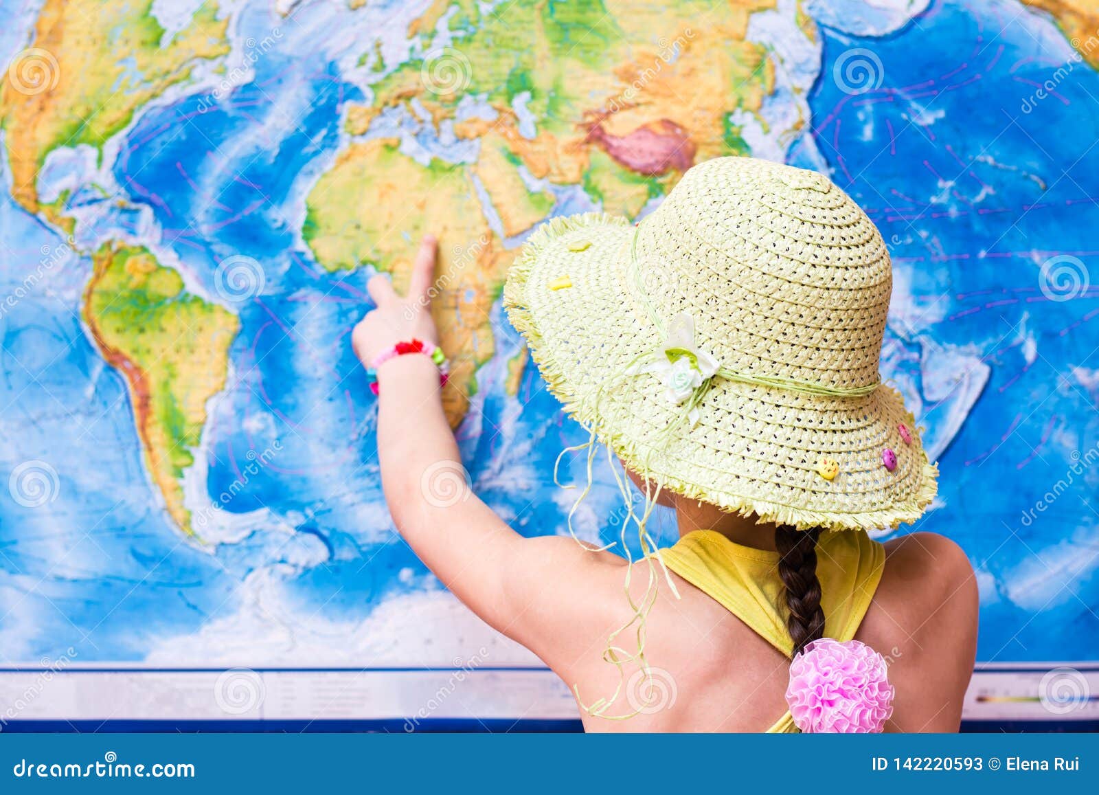 Girl in a Hat Points To a World Map with a Finger Stock Image - Image ...