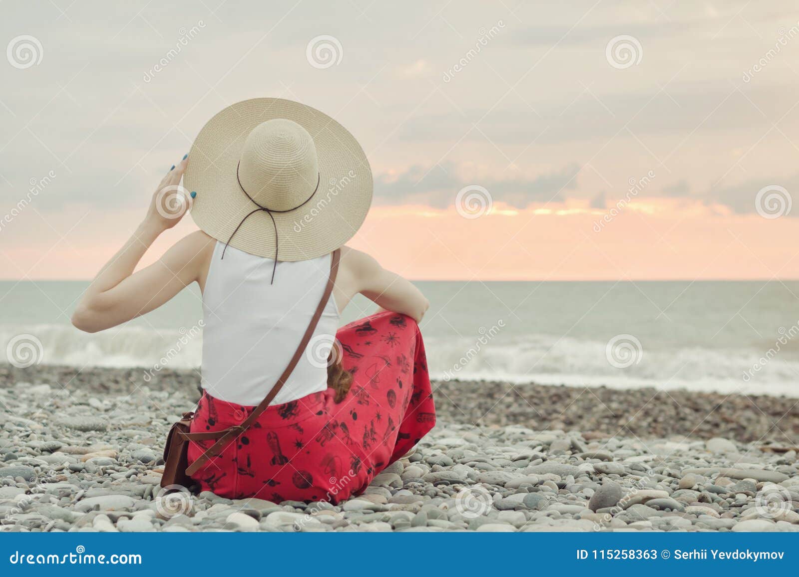 Girl in a Hat Sits on a Pebble Beach. Back View Stock Image - Image of ...
