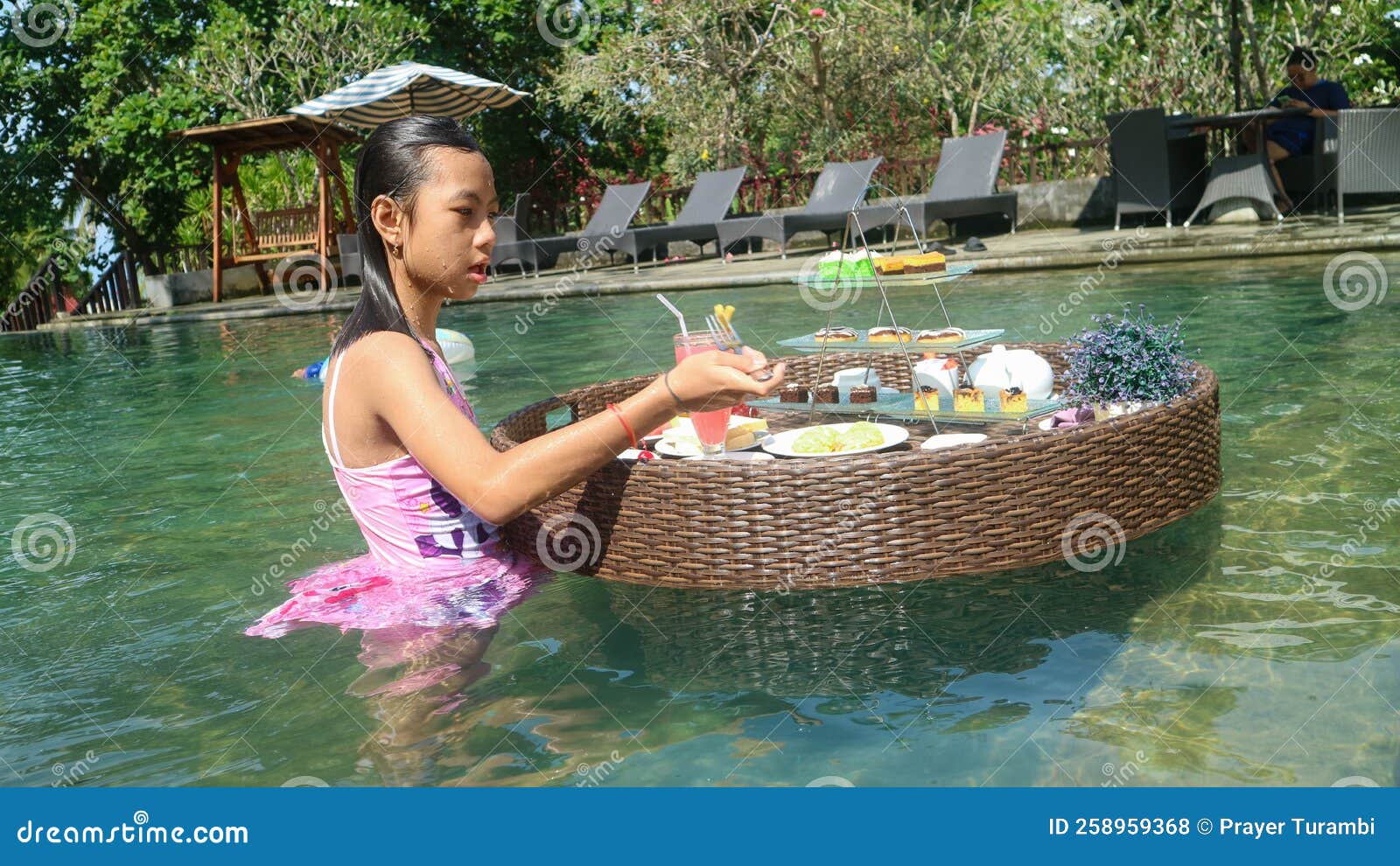 A Girl Having Breakfast Floating in the Pool Stock Photo - Image of ...