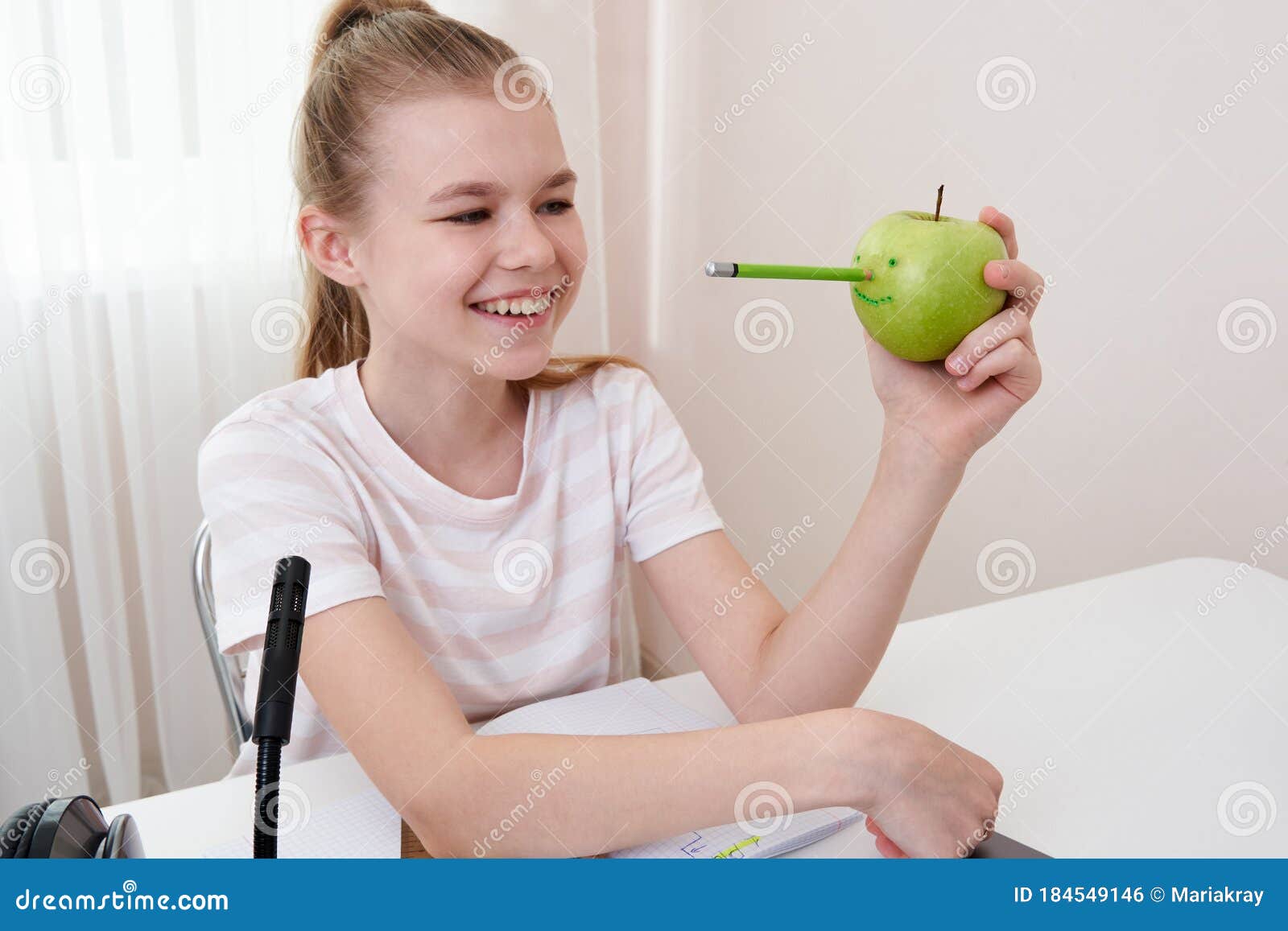 Girl Having Fun with Green Apple while Doing Homework, Joy Concept ...