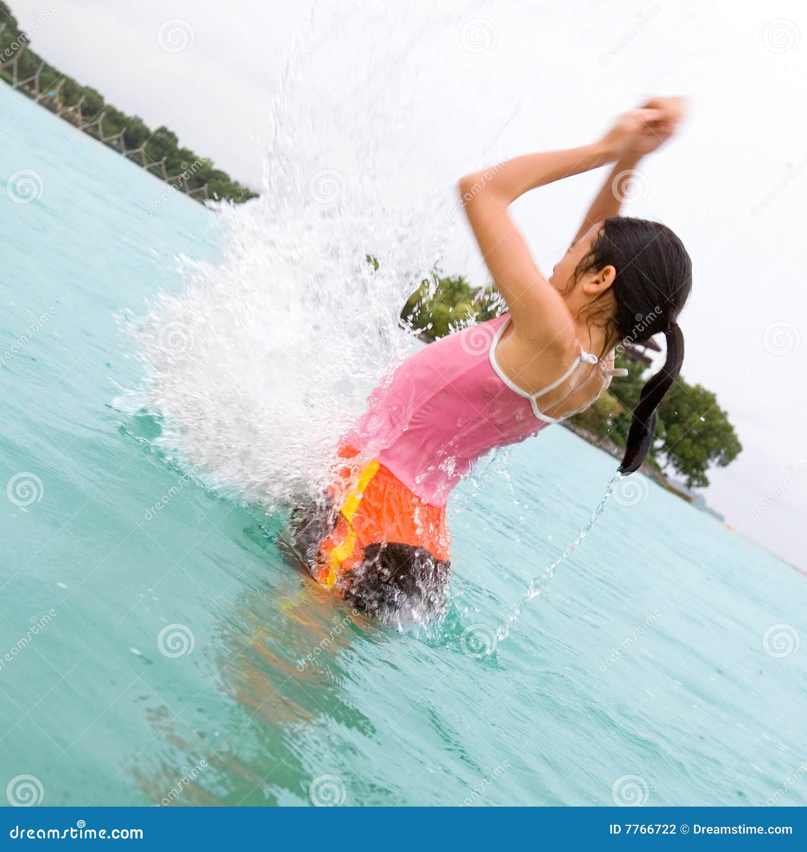 Girl Having Fun Splashing Water In The Lagoon Stock Photo - Image of ...