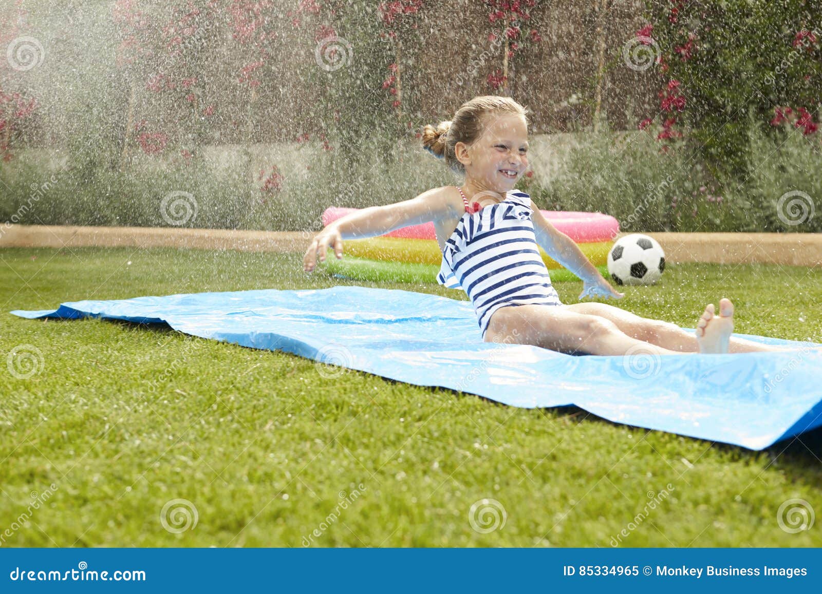 Girl Having Fun on Water Slide in Garden Stock Image - Image of people ...