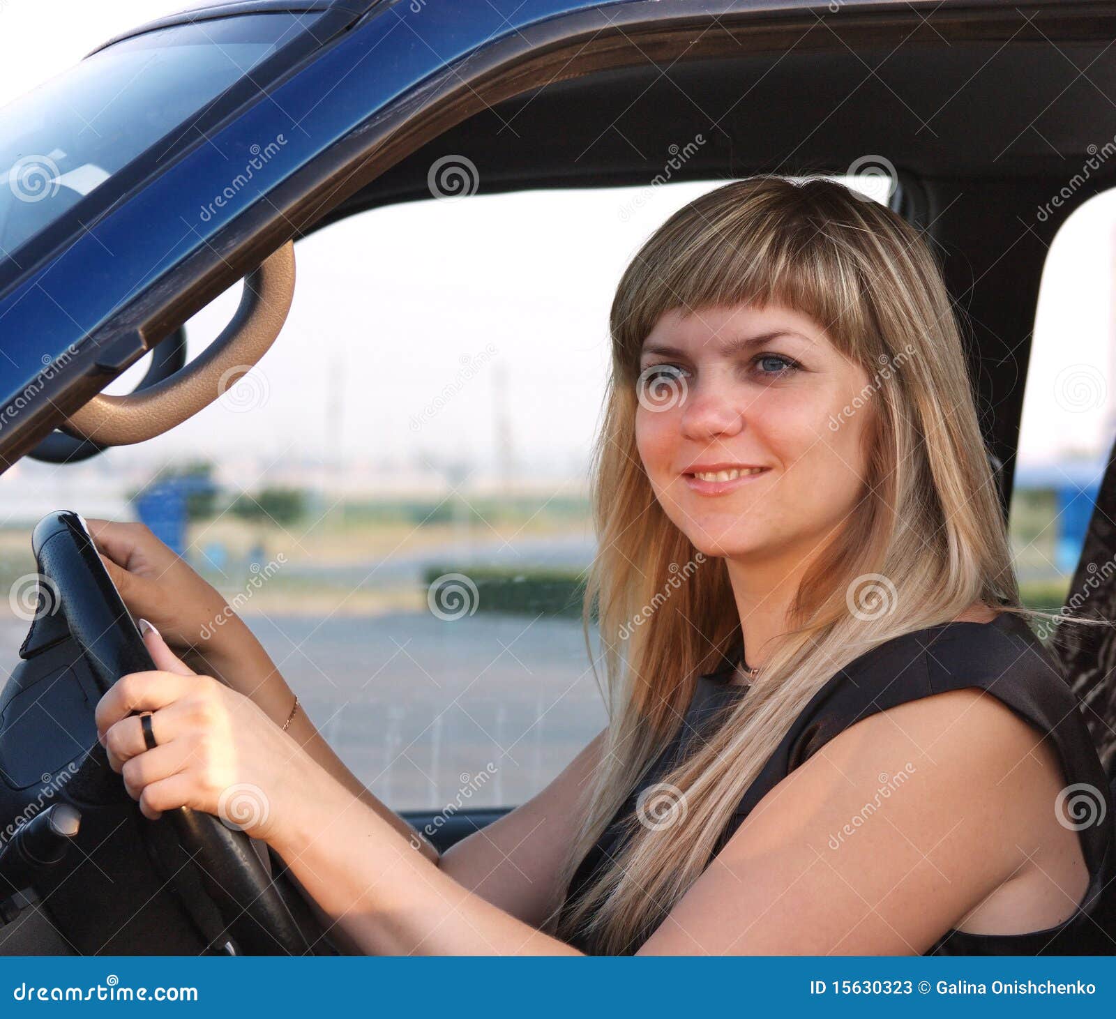 Girl after the helm of car stock image. Image of blonde - 15630323