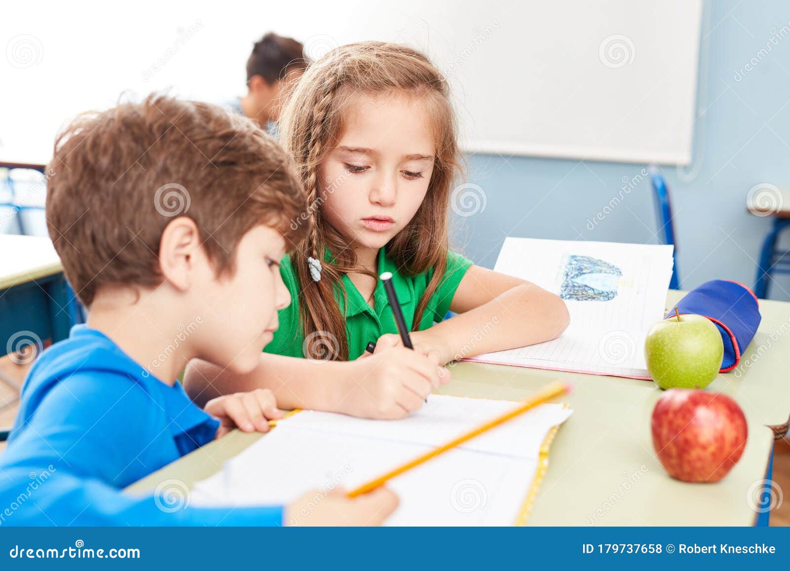 Girl Helps Students in Elementary School Lessons Stock Photo - Image of ...