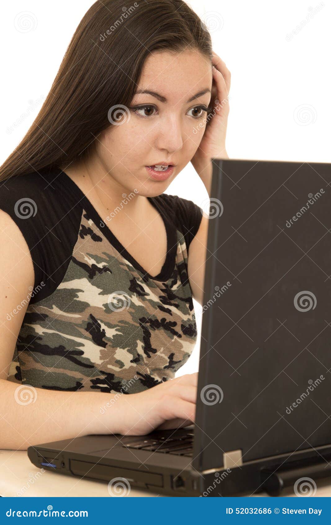 Girl with Her Hand To Her Head while Using the Computer Stock Photo ...