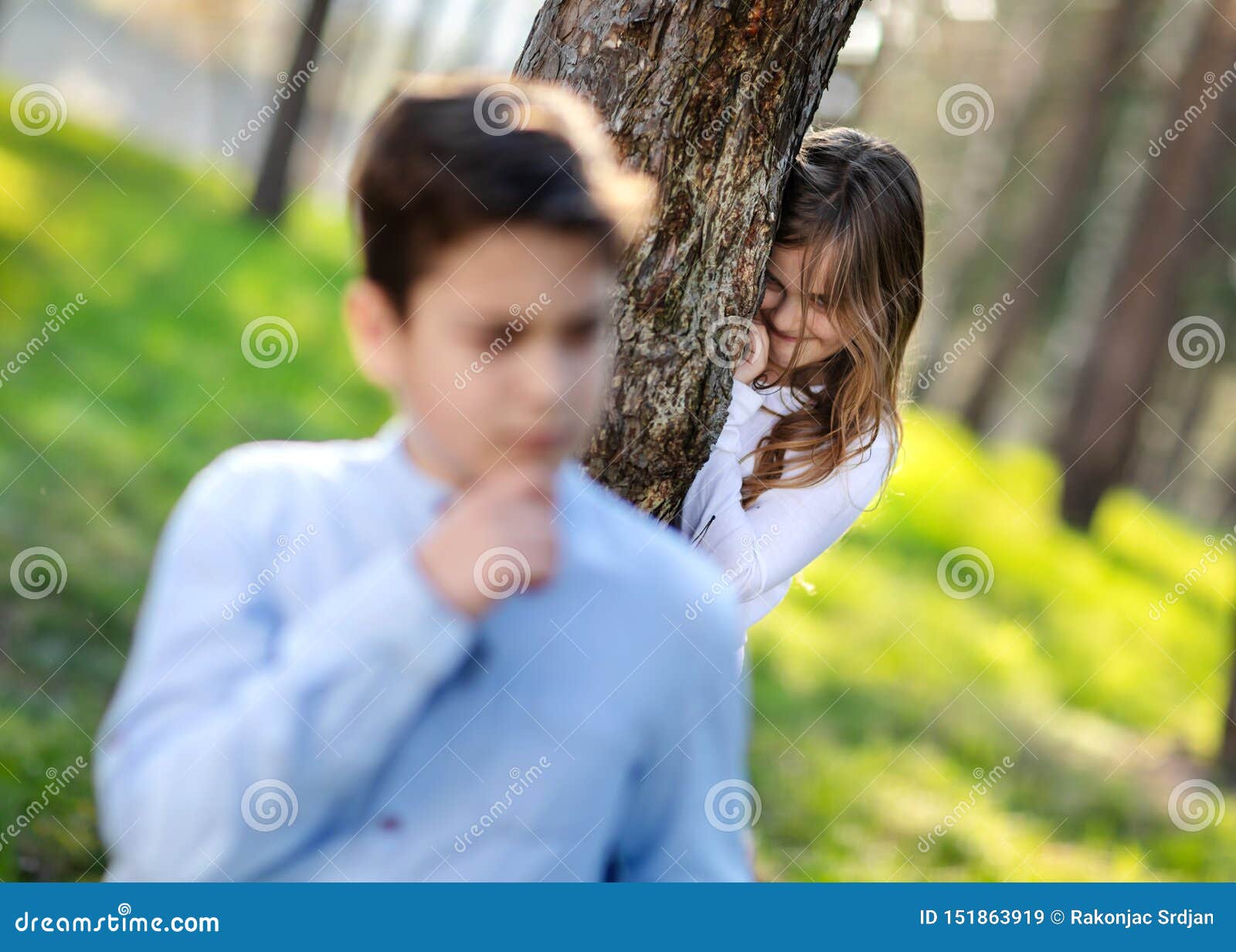 Boy And Girl Playing Hide And Seek In The Park Girl Watching On Boyfriend Stock Image Image 9170