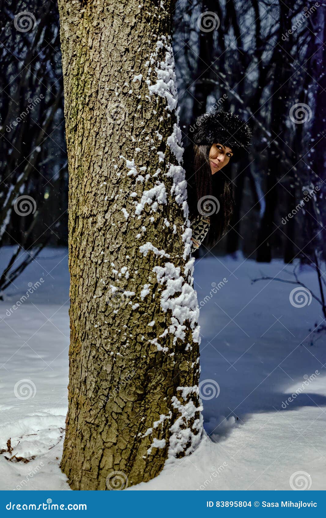 Girl Hiding Behind the Tree on a Snowy Evening Stock Photo - Image of ...