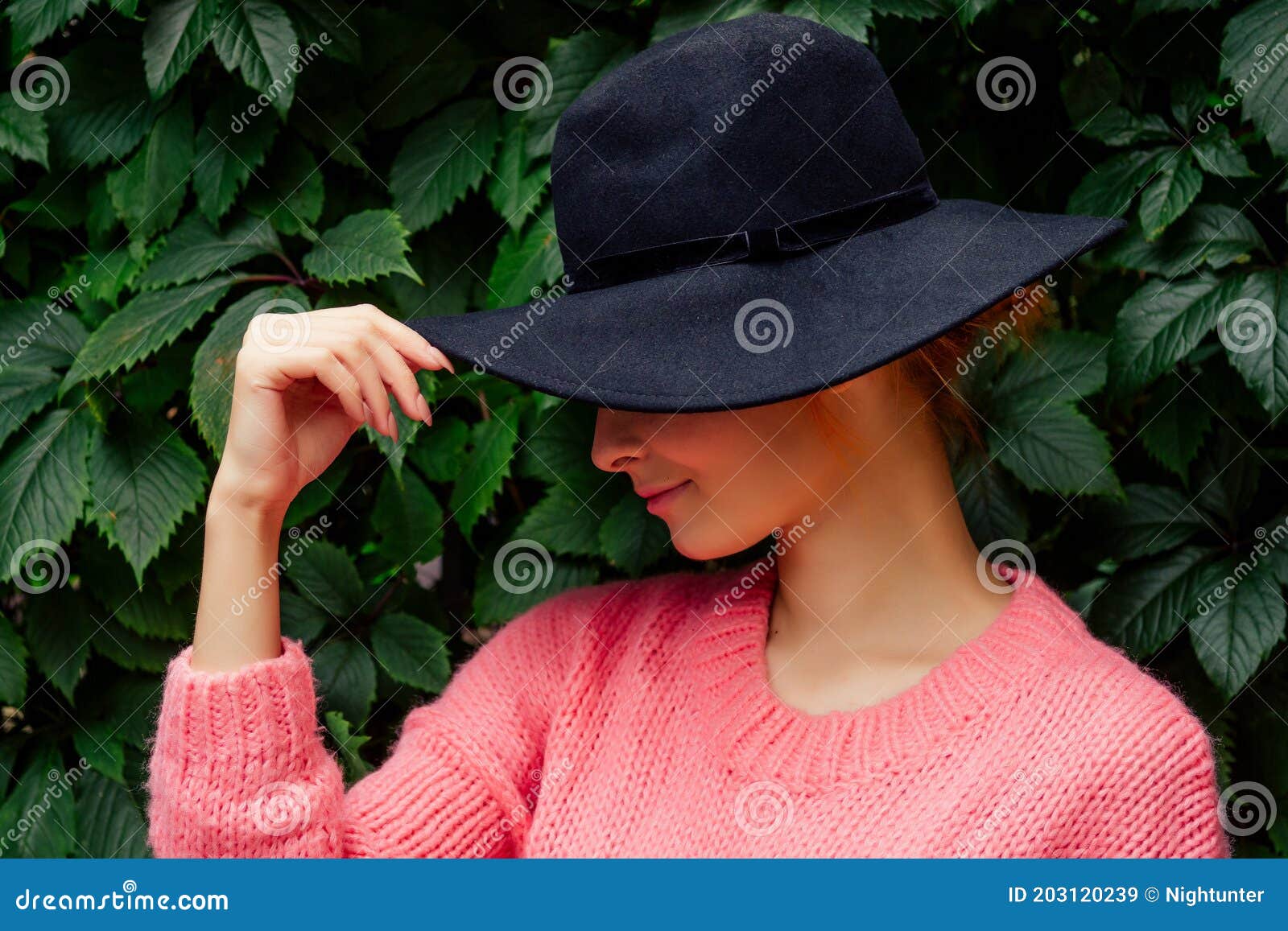 Girl Hiding Her Face Behind a Black Hat Outdoors Stock Image - Image of ...