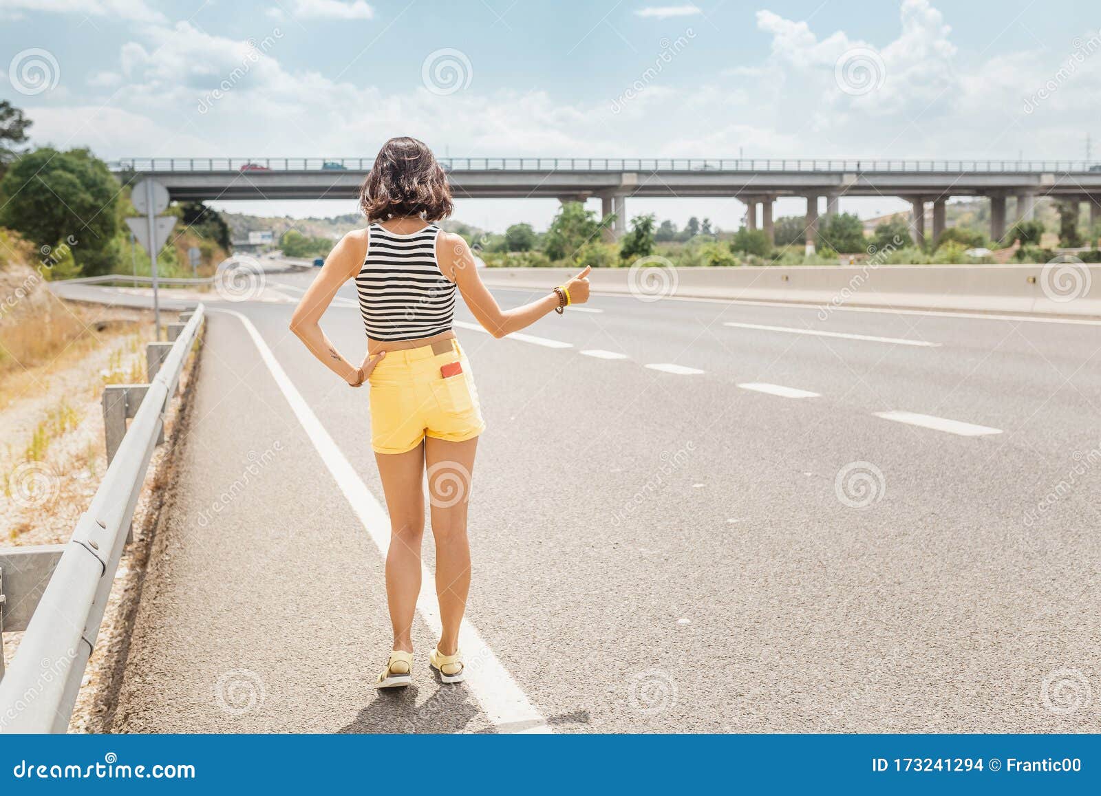 Girl hitchhiking on road stock photo. Image of route - 173241294