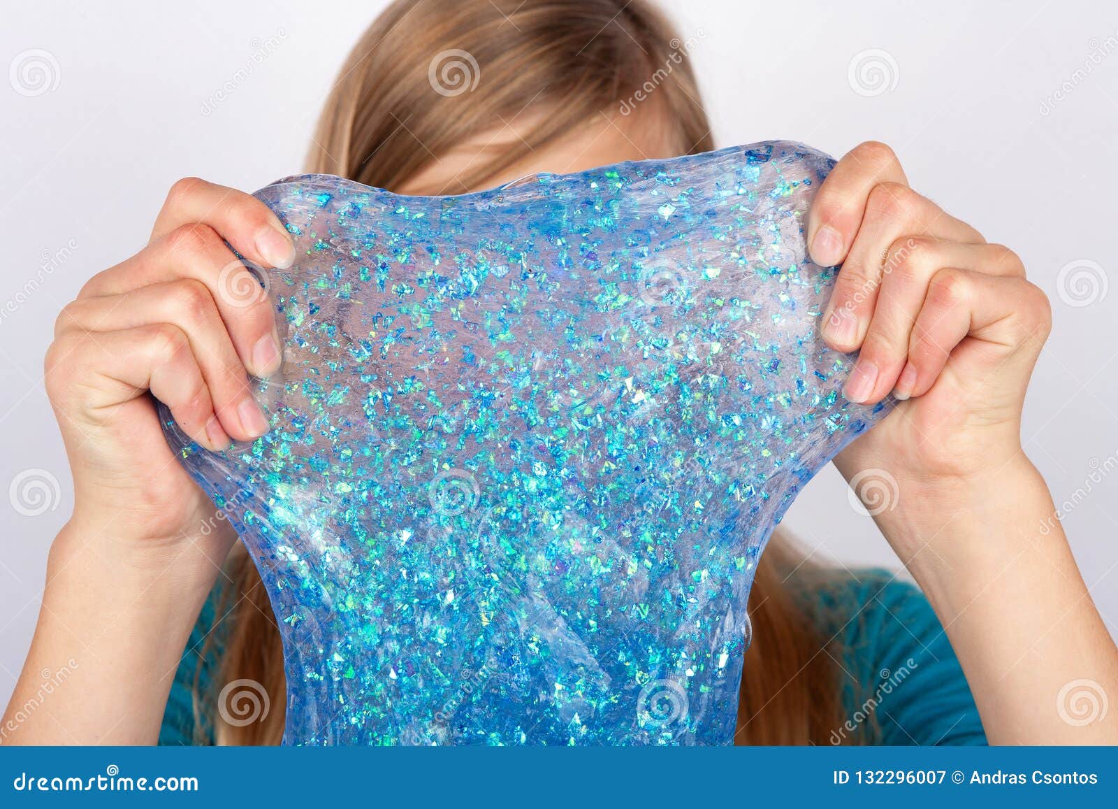 Girl Holding Blue Glitter Slime in Front of Her Face Stock Image ...