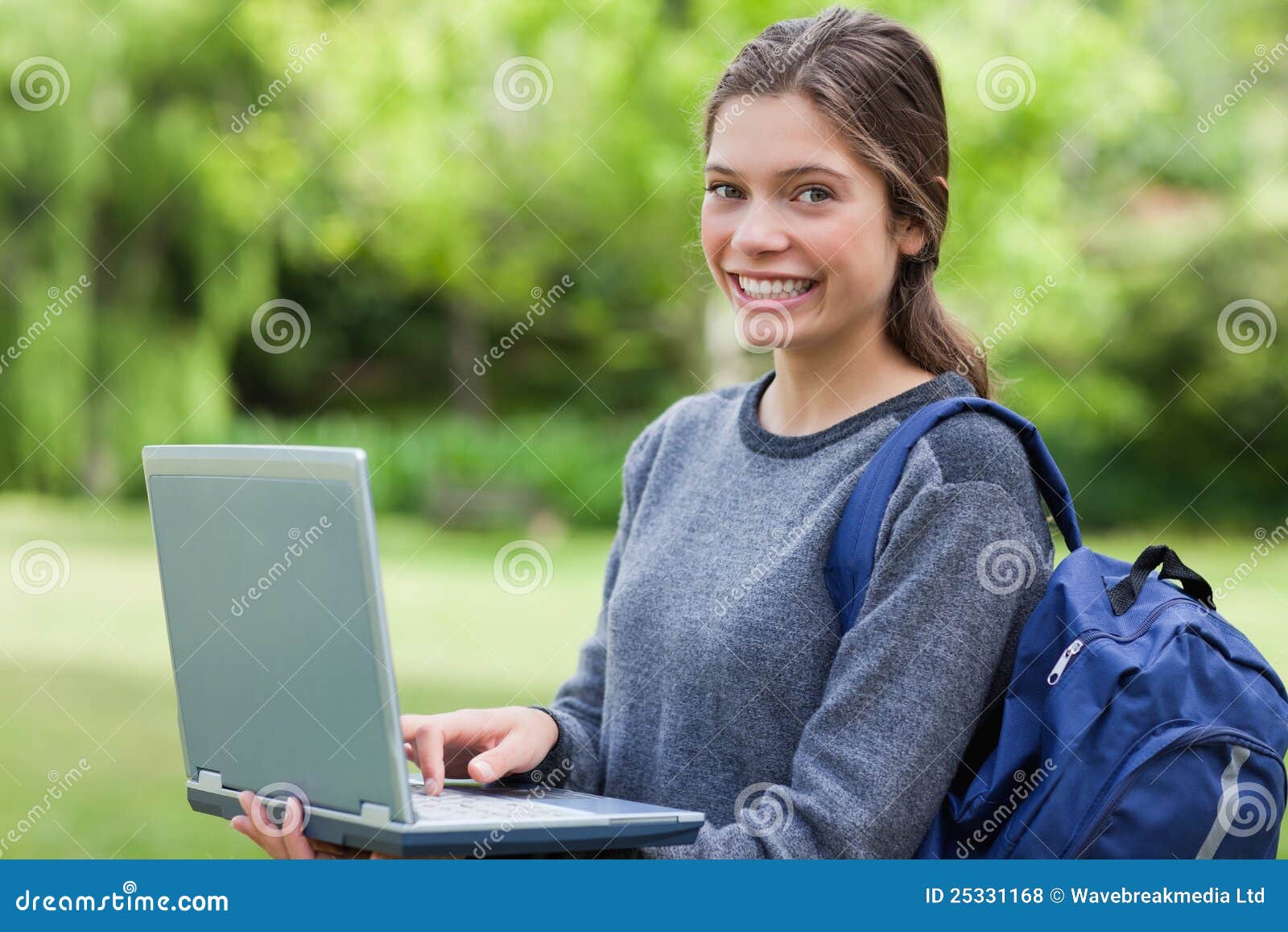 Girl Holding Her Laptop while Smiling Stock Photo - Image of looking ...