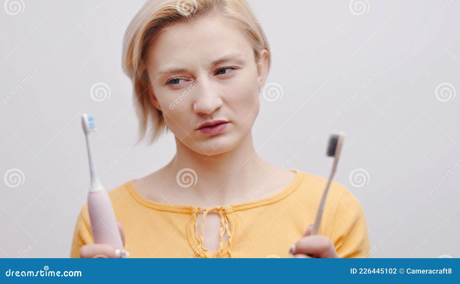 Girl Holding a Manual and an Electric Ultrasound Toothbrush in Her ... Girl Holding a Manual and an Electric Ultrasound Toothbrush in Her ...