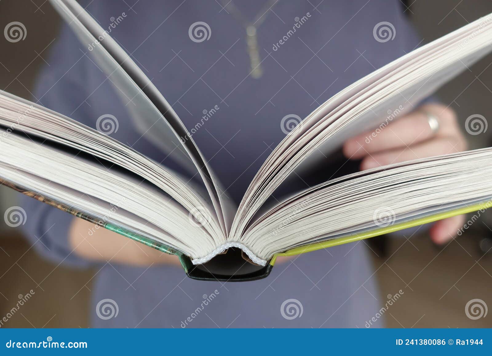 Girl Holding an Open Book in Front of Her Stock Photo - Image of ...