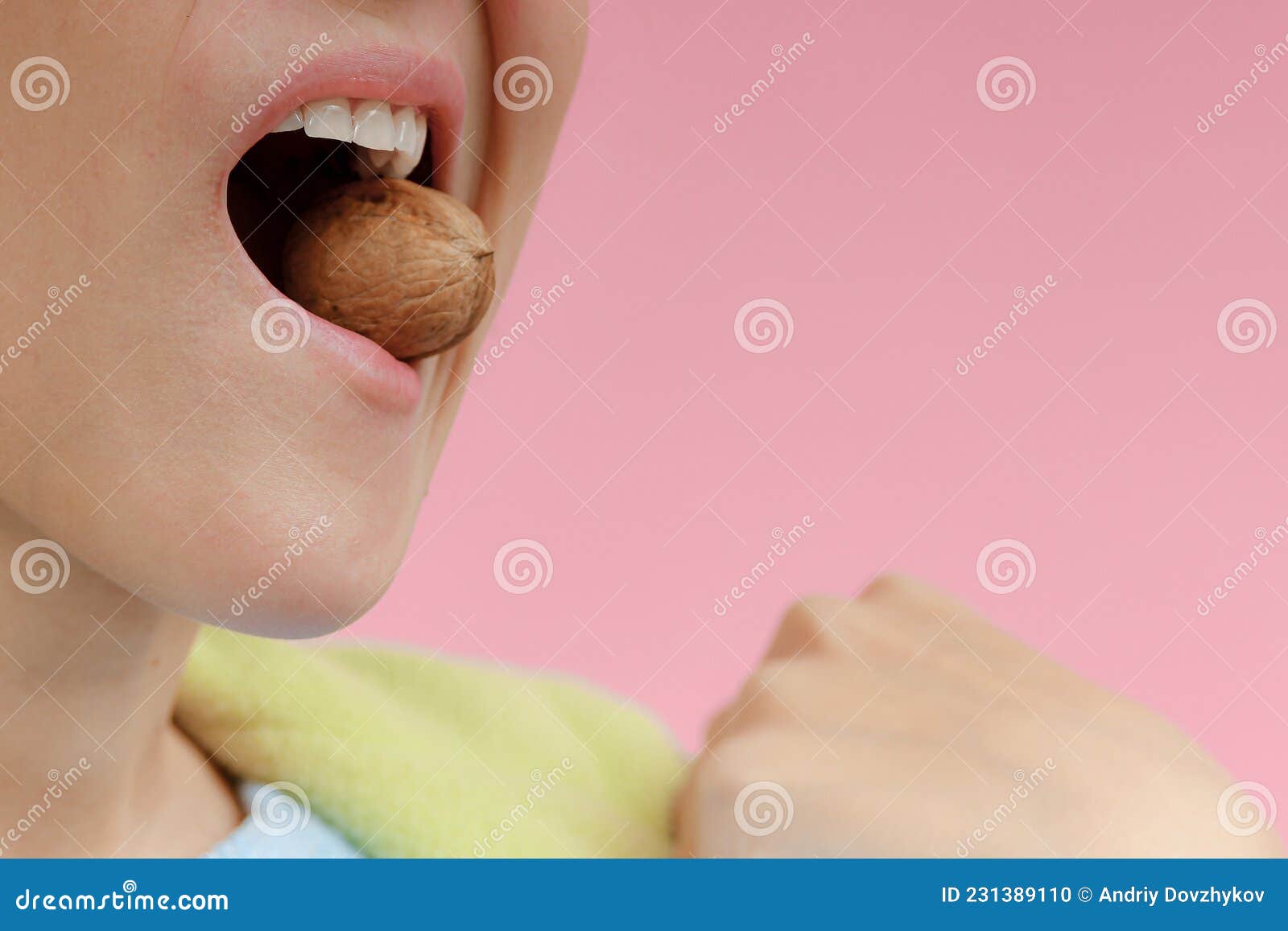 Girl Holding Walnuts with White Teeth on a Pink Background Stock Photo ...