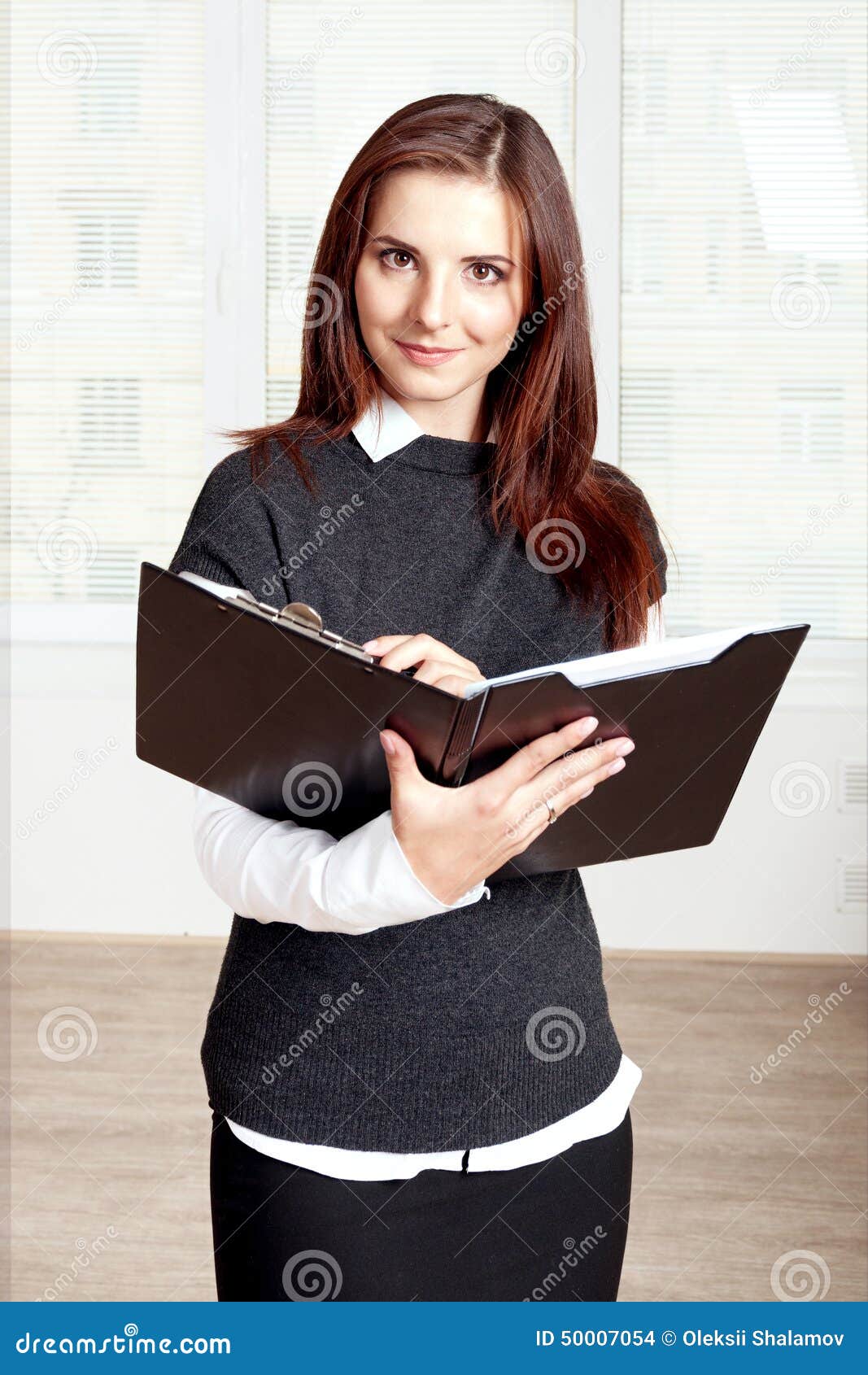 Girl Holds a Black Folder Open in One Hand and in the Other she Stock ...