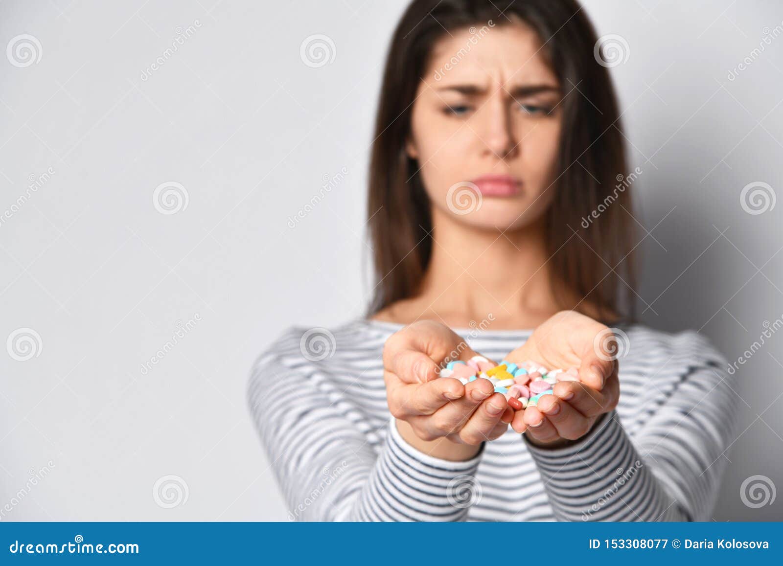 Girl Holds in Her Hands a Handful of Various Multi-colored Medication ...
