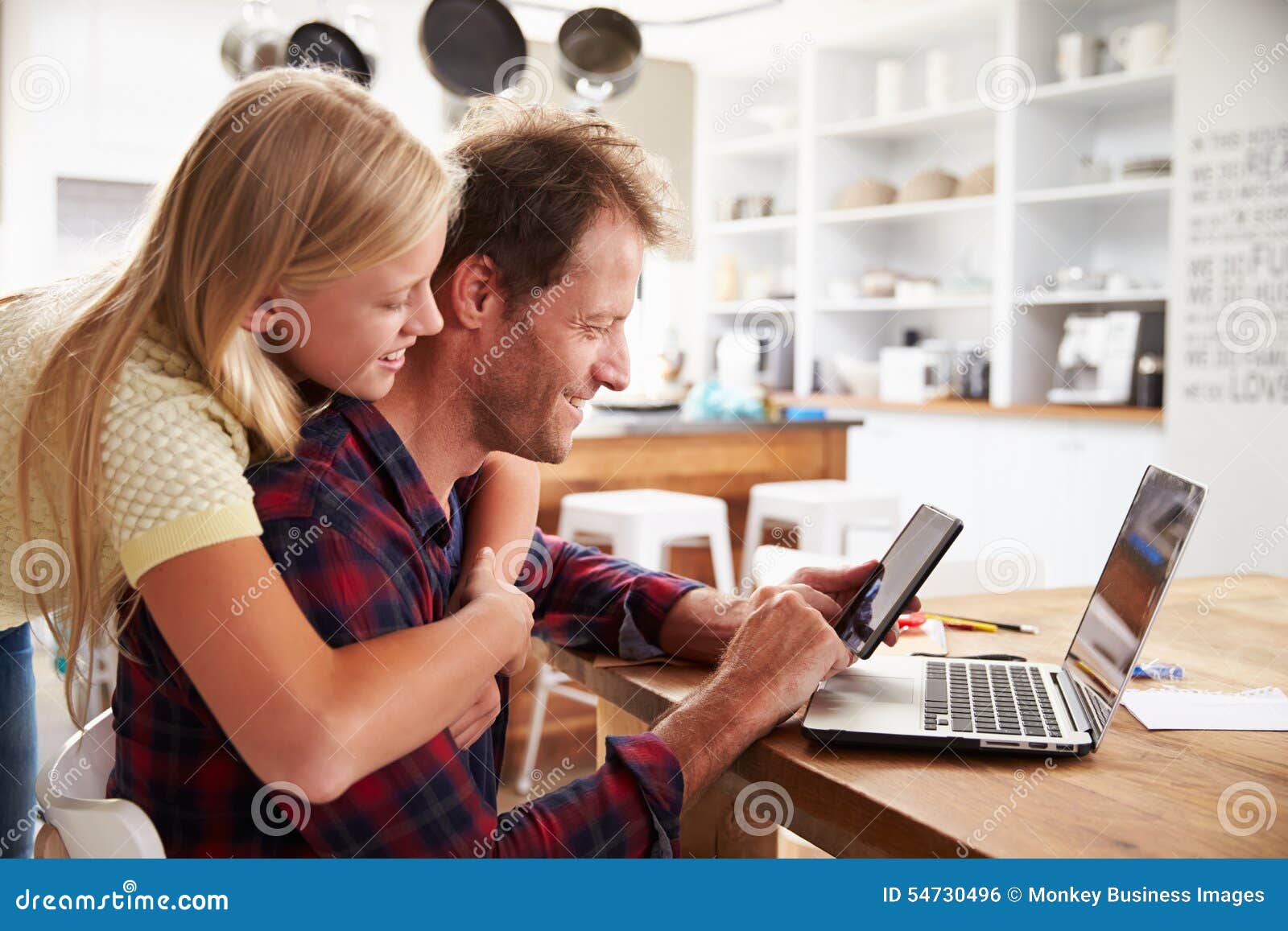 Girl Hugging Her Father, Working on Laptop at Home Stock Photo - Image ...