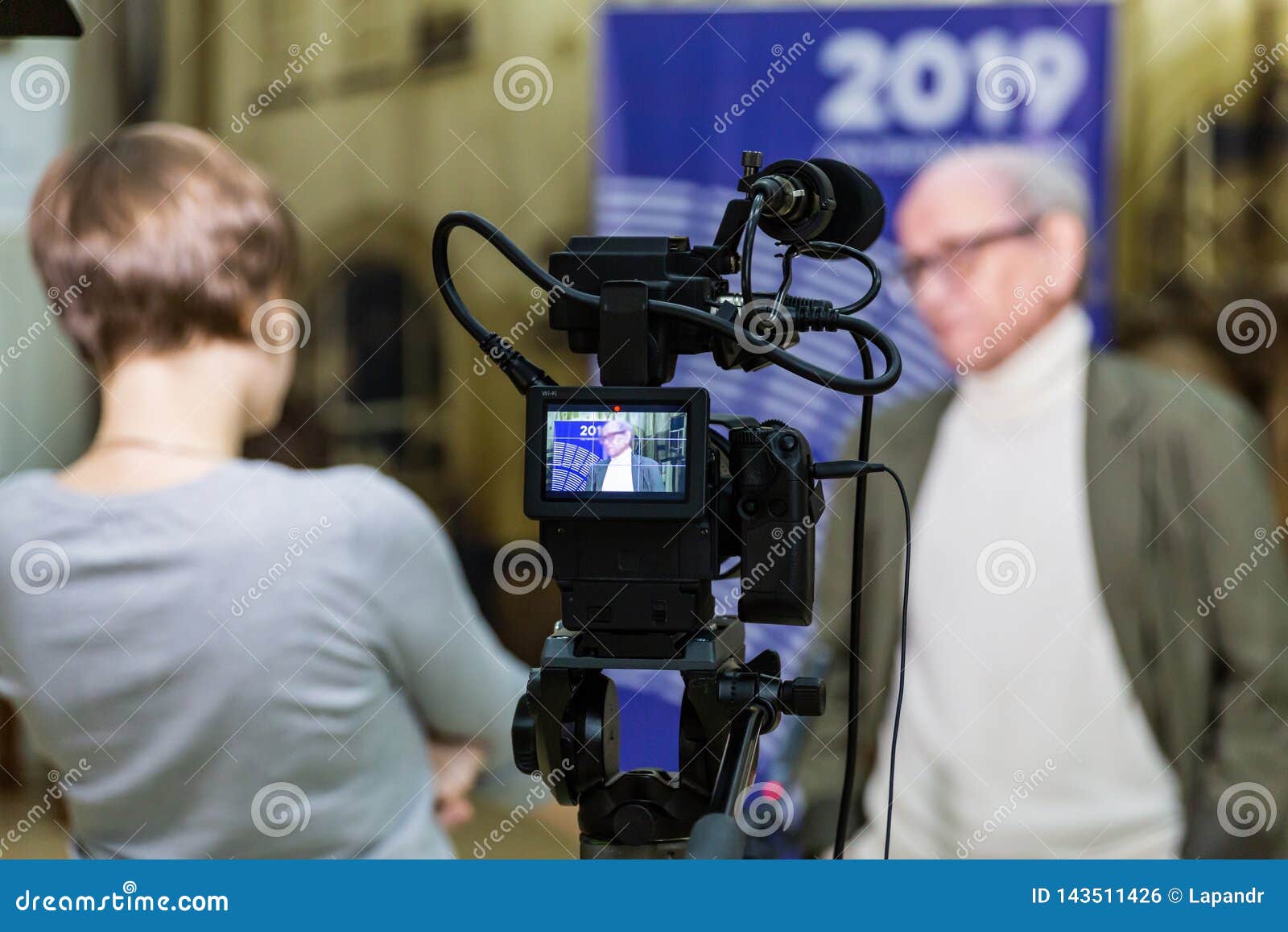 The Girl Interviews the Man. Video Shooting in the Interior Editorial ...
