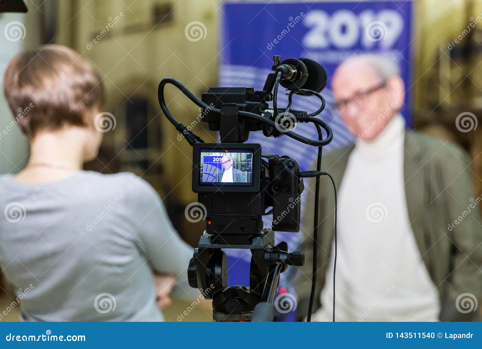 The Girl Interviews the Man. Video Shooting in the Interior Editorial ...