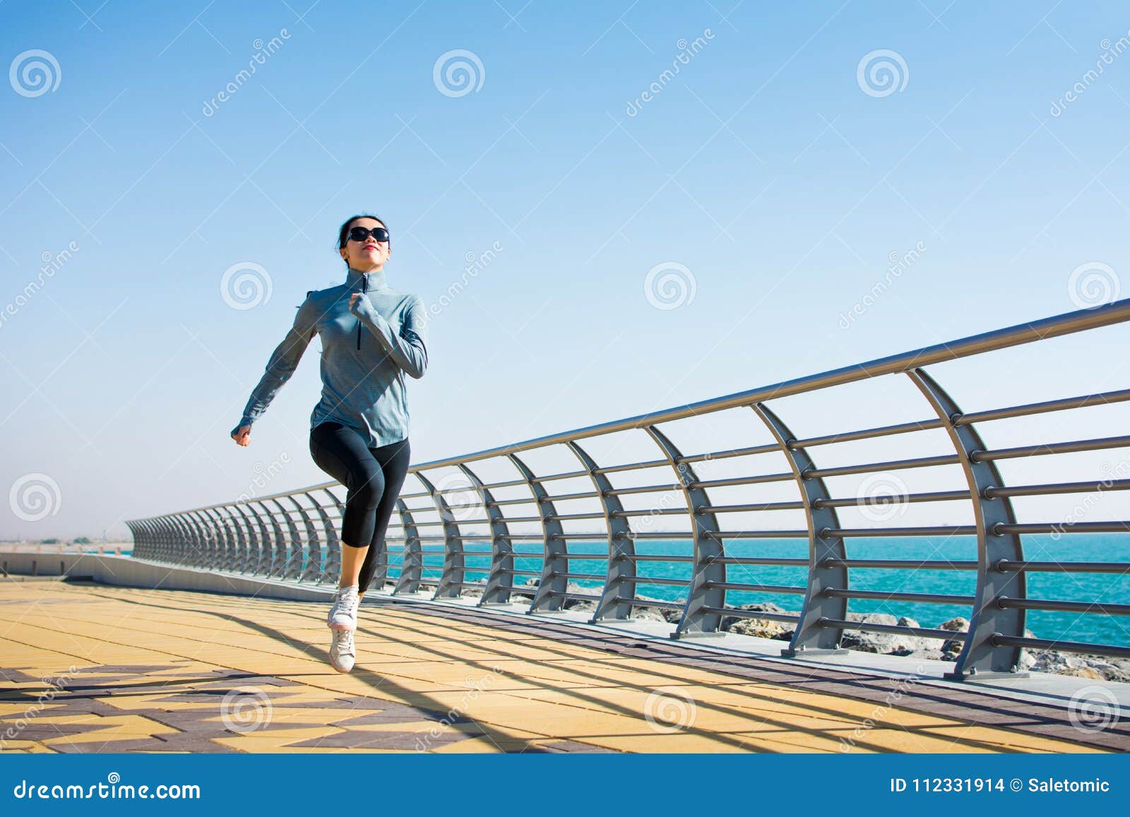 Girl Jogging on the Boardwalk by the Sea Stock Photo - Image of person ...