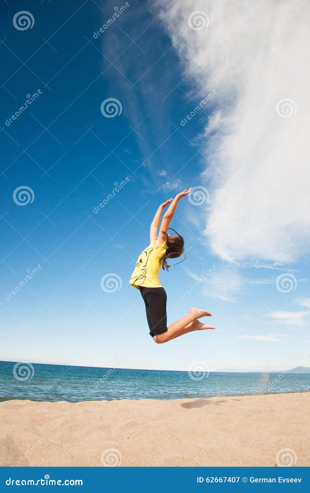 Girl jumping on the beach stock image. Image of blue - 62667407