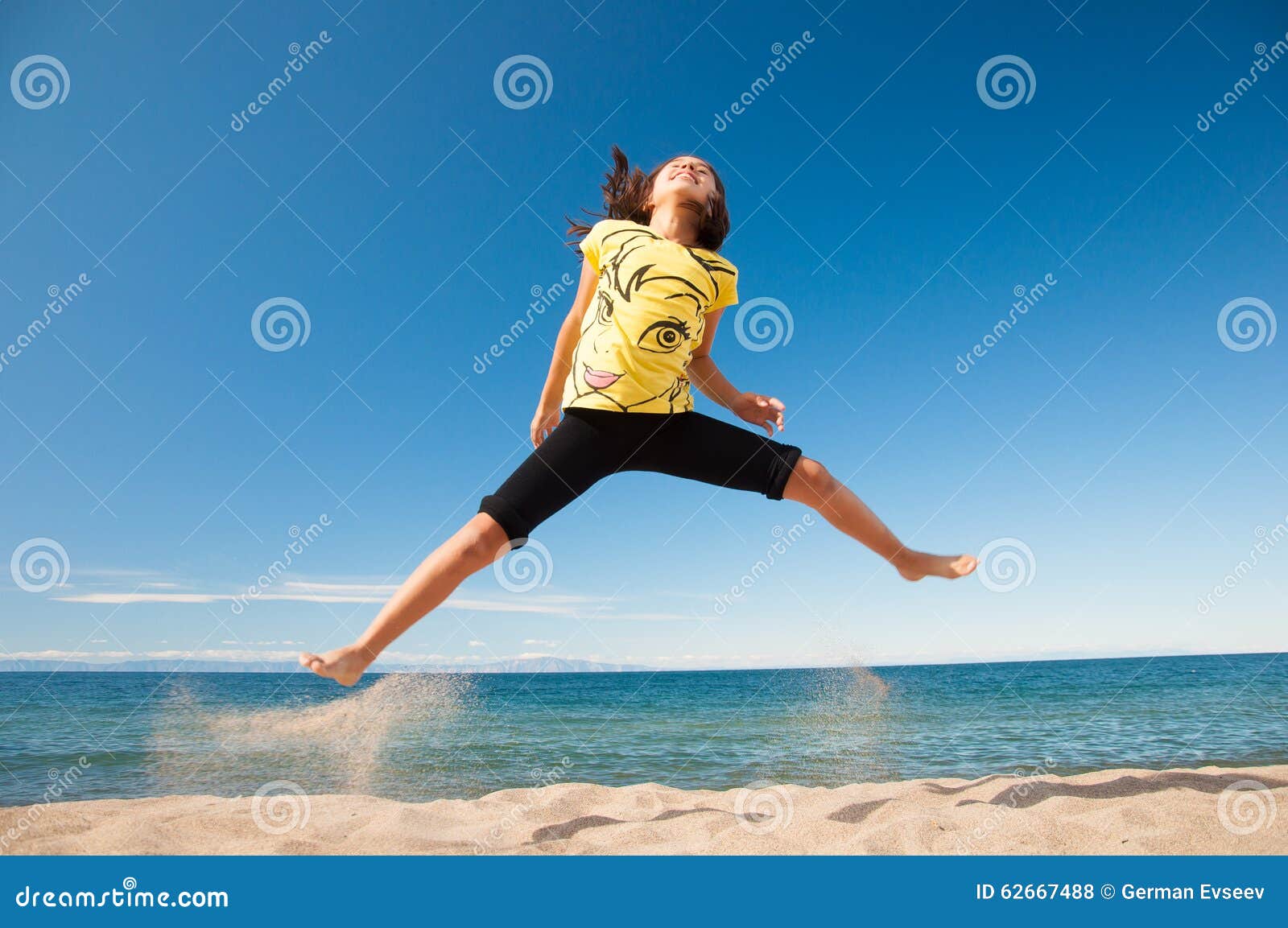 Girl jumping on the beach stock photo. Image of sand - 62667488