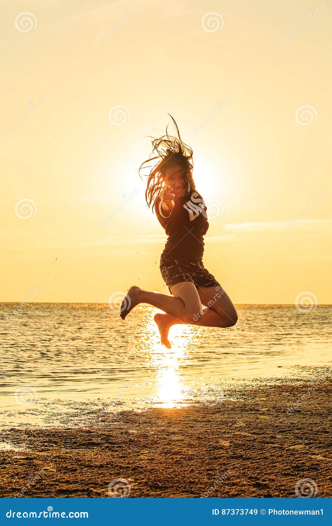 Girl Jumping on the Beach with the Sun. Stock Image - Image of legs ...
