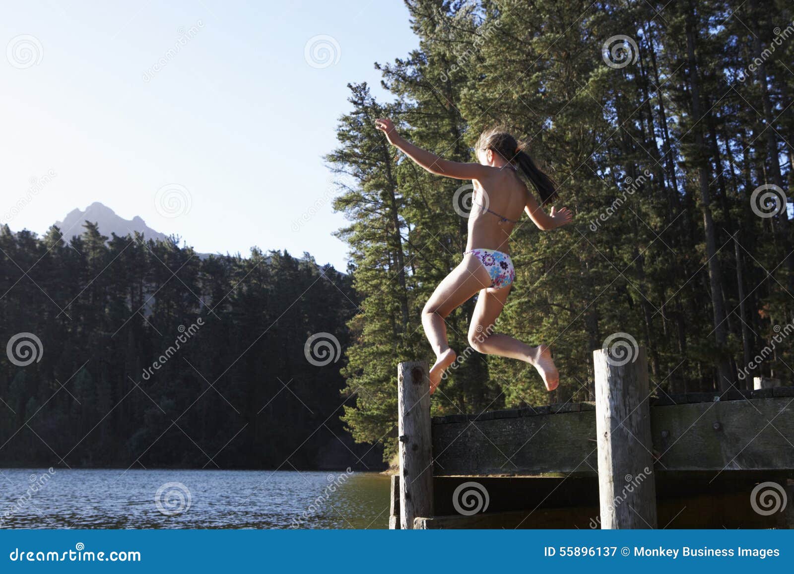 Girl Jumping from Jetty into Lake Stock Image - Image of pier, girl ...