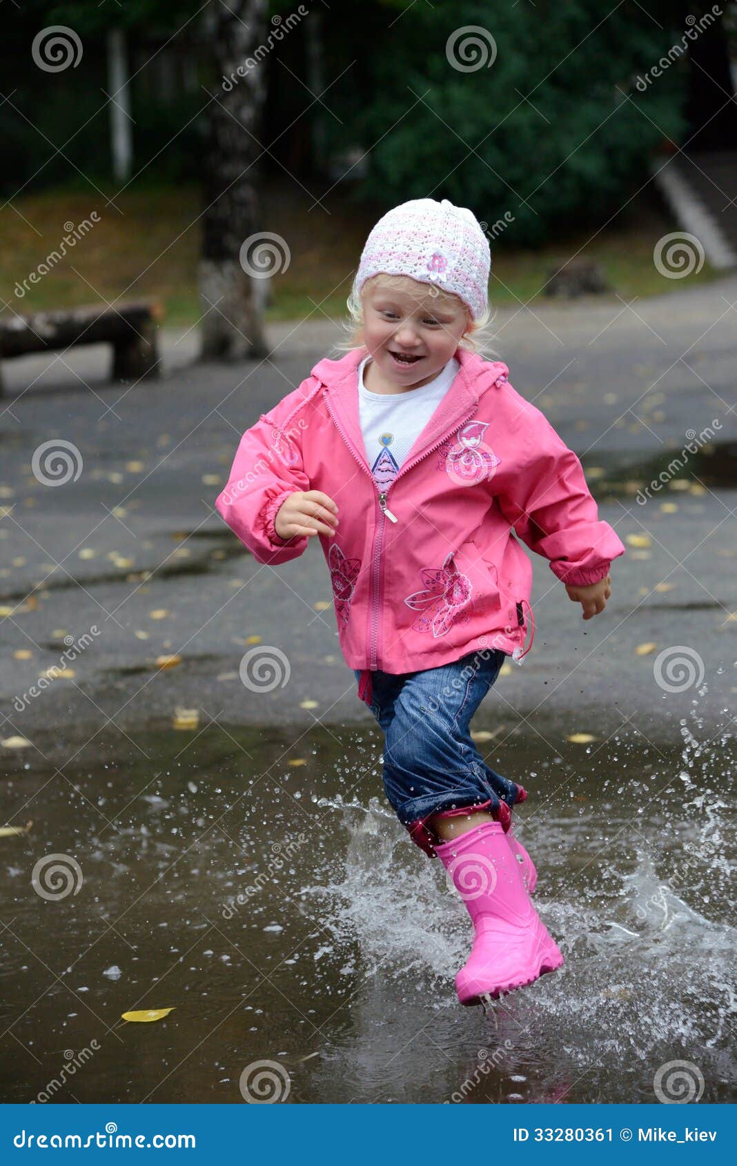 Girl jumping in puddles stock image. Image of autumn - 33280361