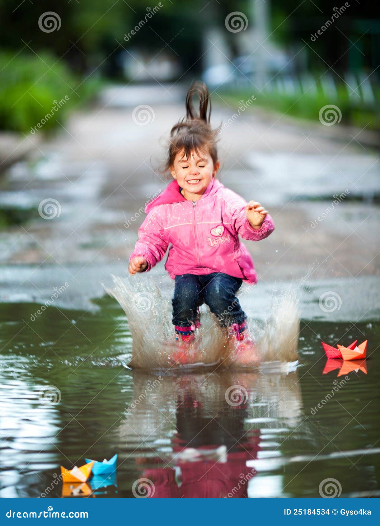 Girl jumps into a puddle stock photo. Image of messy - 25184534