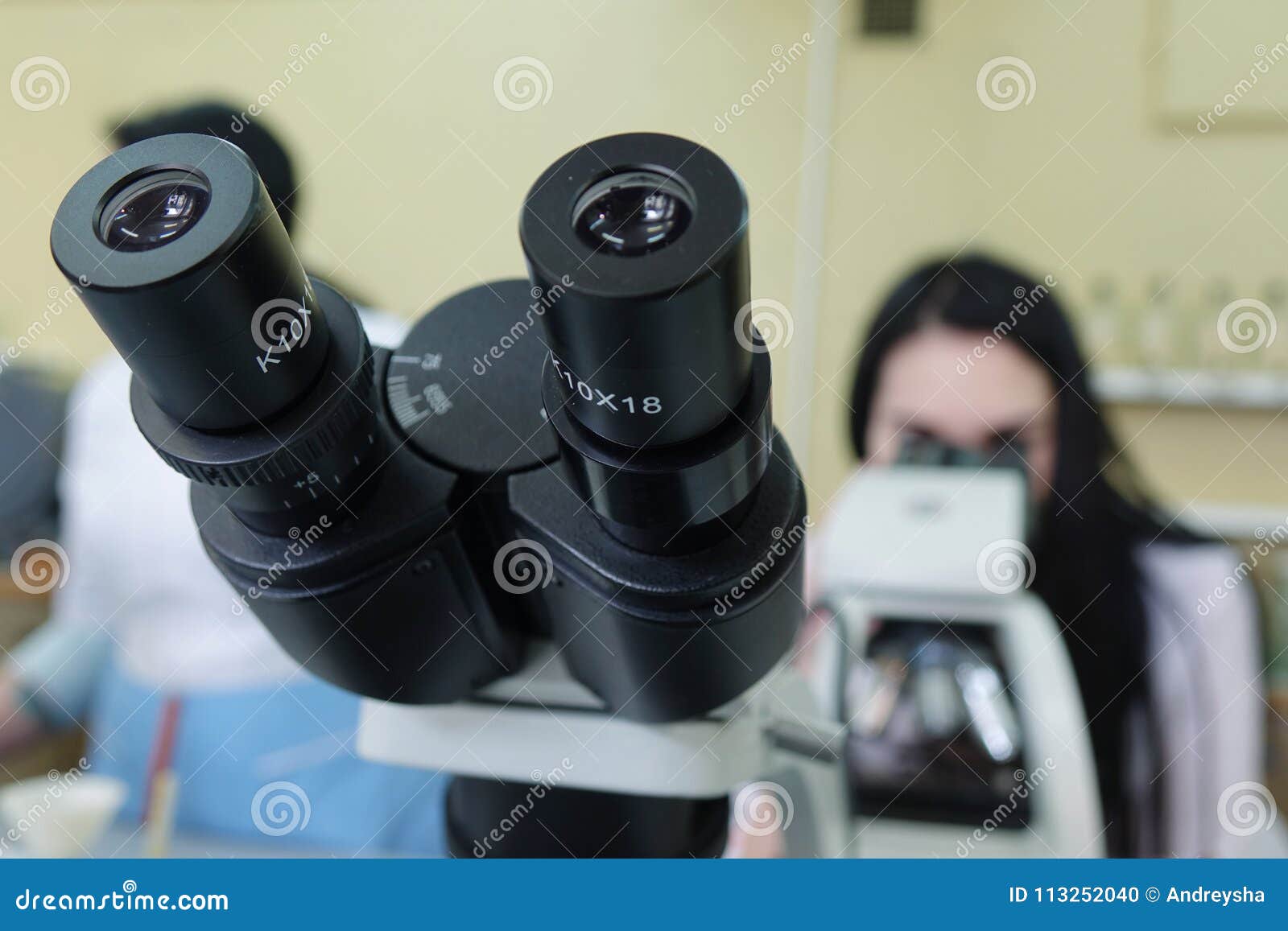 The Girl-laboratory Assistant Works with a Microscope in the Laboratory ...