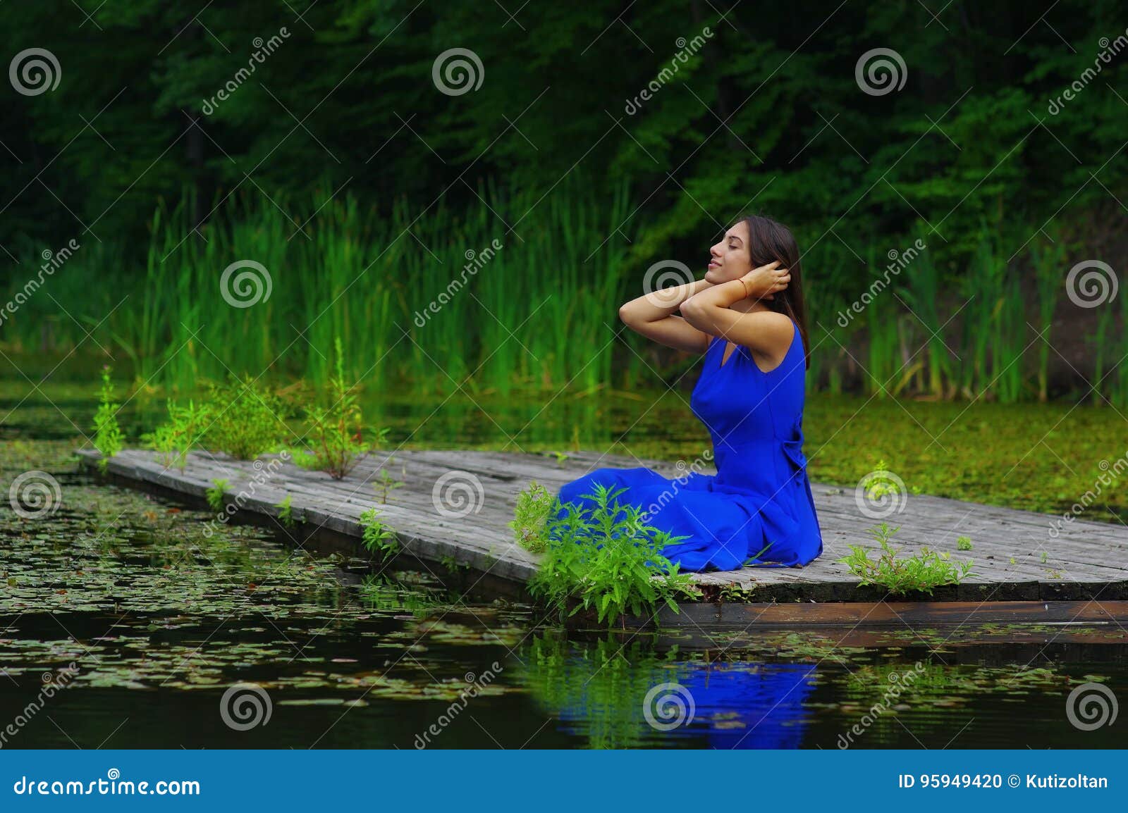 Girl by the lake posing 2 stock photo. Image of coastline - 95949420
