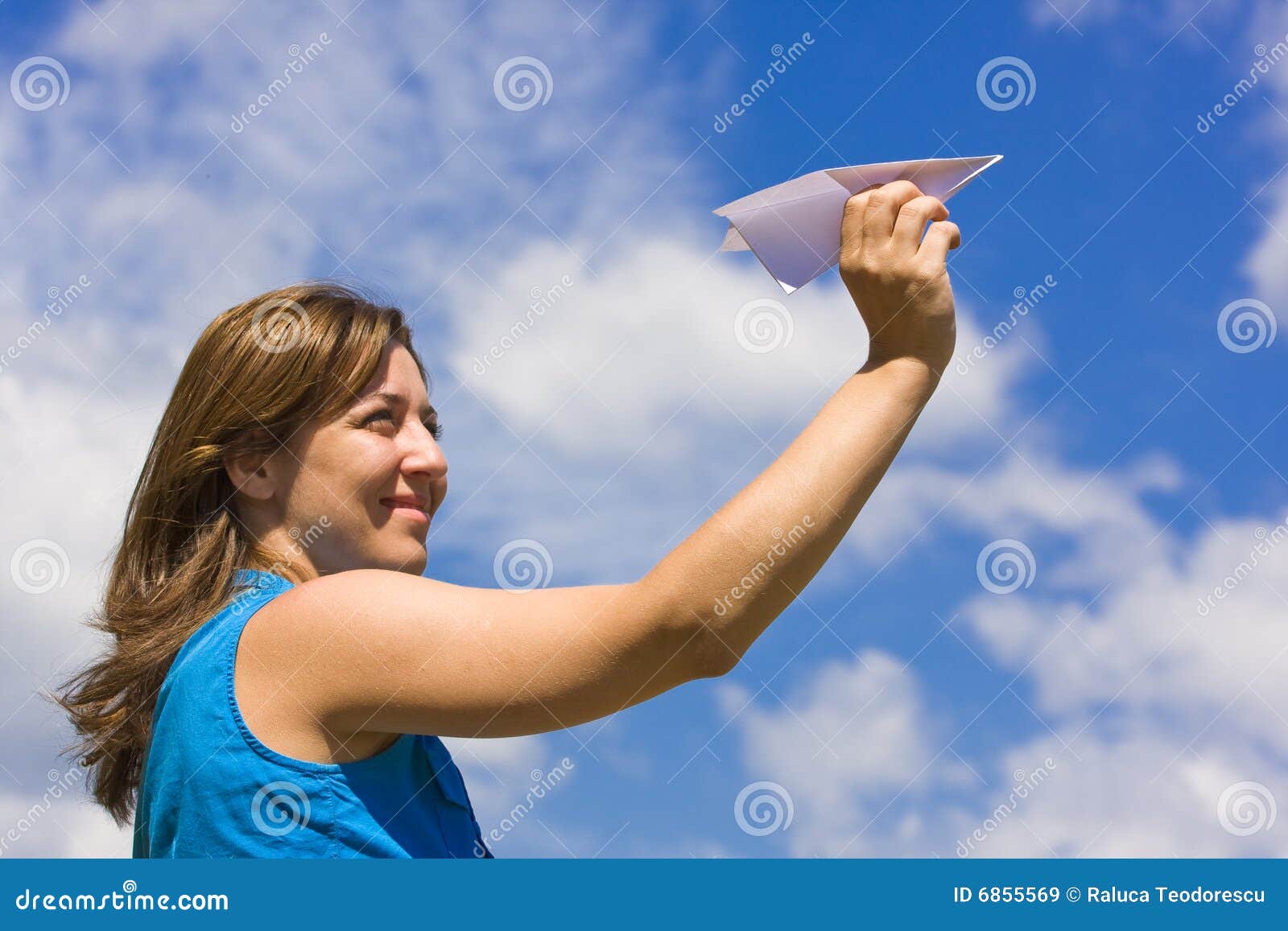 A Girl Is Launching A Paper Airplane From A Window At Sunset. Support ...