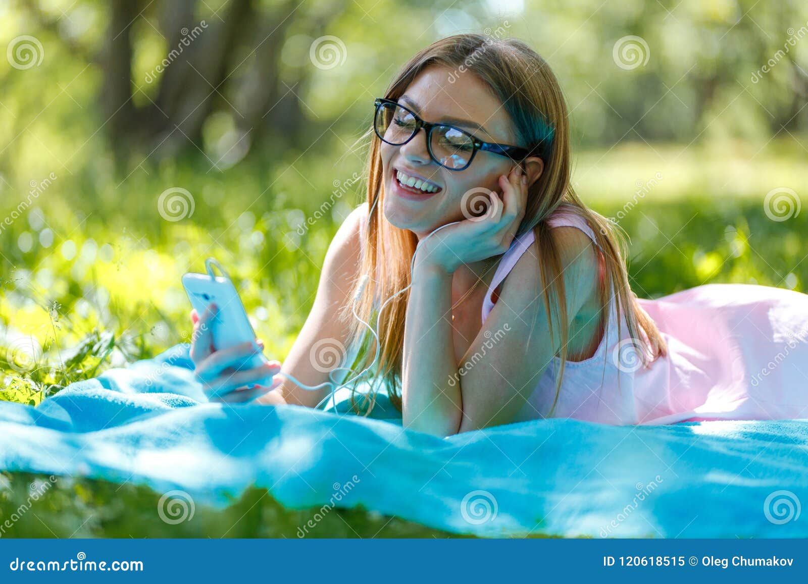 Woman Lay Down or Relaxing on Green Grass Listening Music with ... Woman Lay Down or Relaxing on Green Grass Listening Music with ...