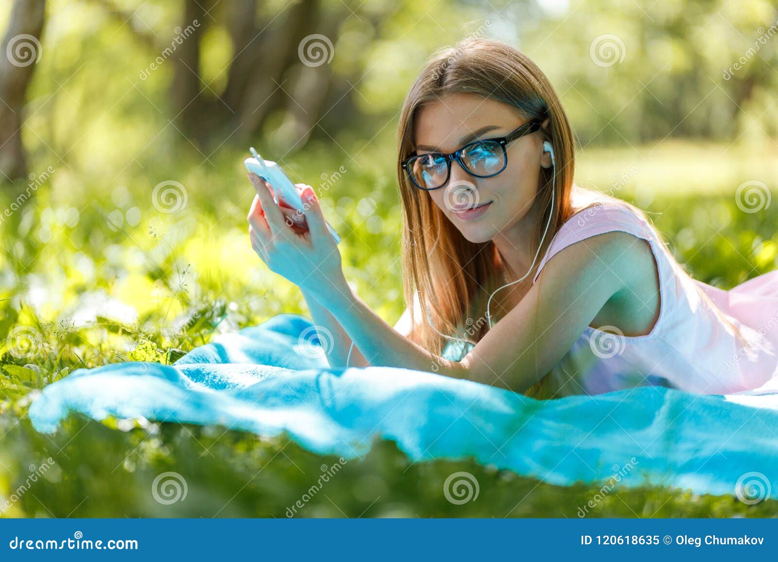 Woman Lay Down or Relaxing on Green Grass Listening Music with ... Woman Lay Down or Relaxing on Green Grass Listening Music with ...