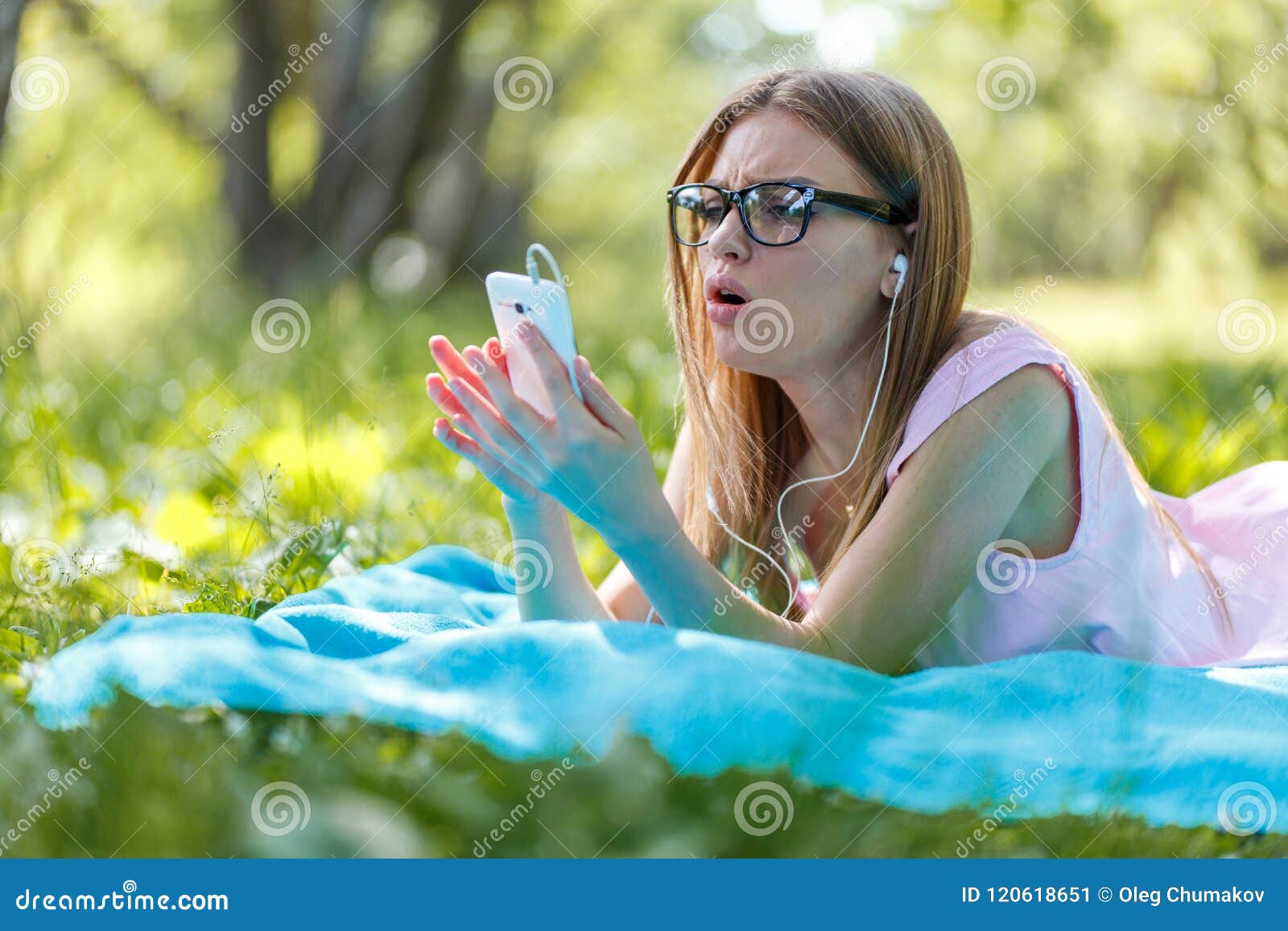 Woman Lay Down or Relaxing on Green Grass Listening Music with ... Woman Lay Down or Relaxing on Green Grass Listening Music with ...