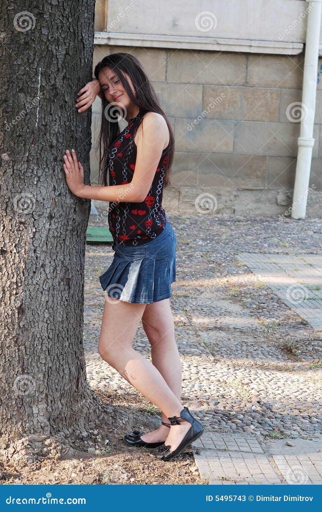 Teenage Girl Leaning On Tree
