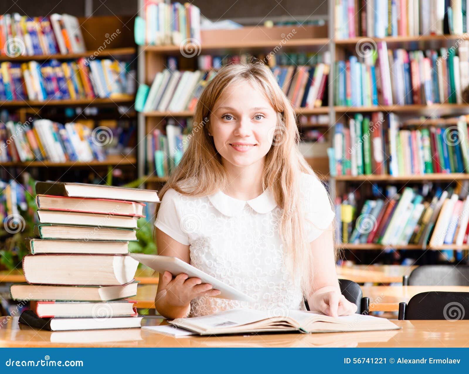 Girl Learning in Library and Reading E-book on Tablet Computer Stock ...