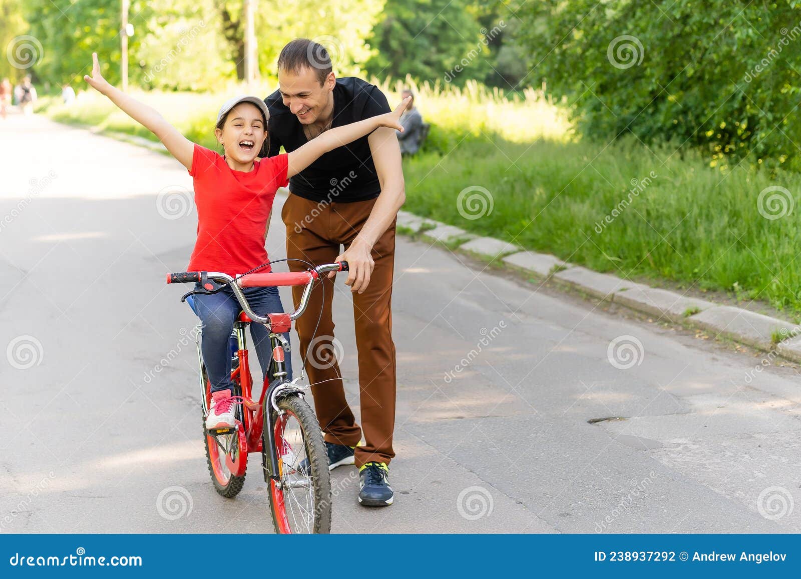 Girl learning to ride bike stock photo. Image of explain - 238937292