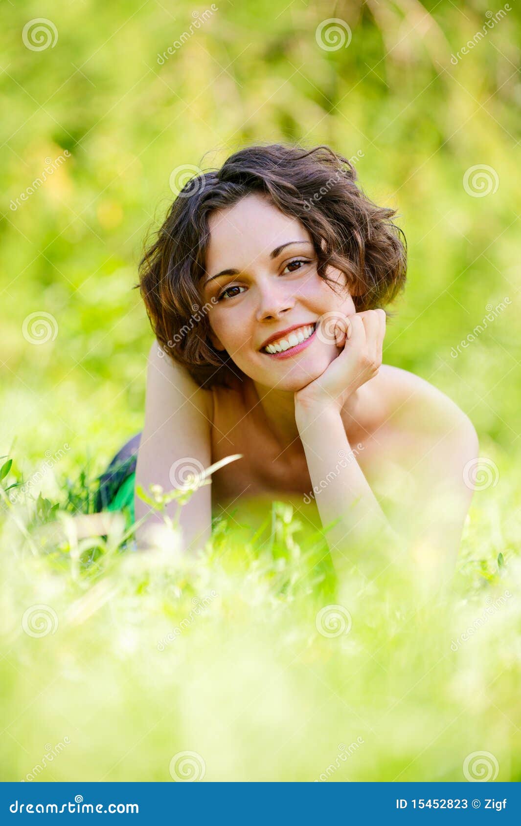 The Girl Lies On The Grass. Happy Smiling Beautiful Girl Lying Among ...