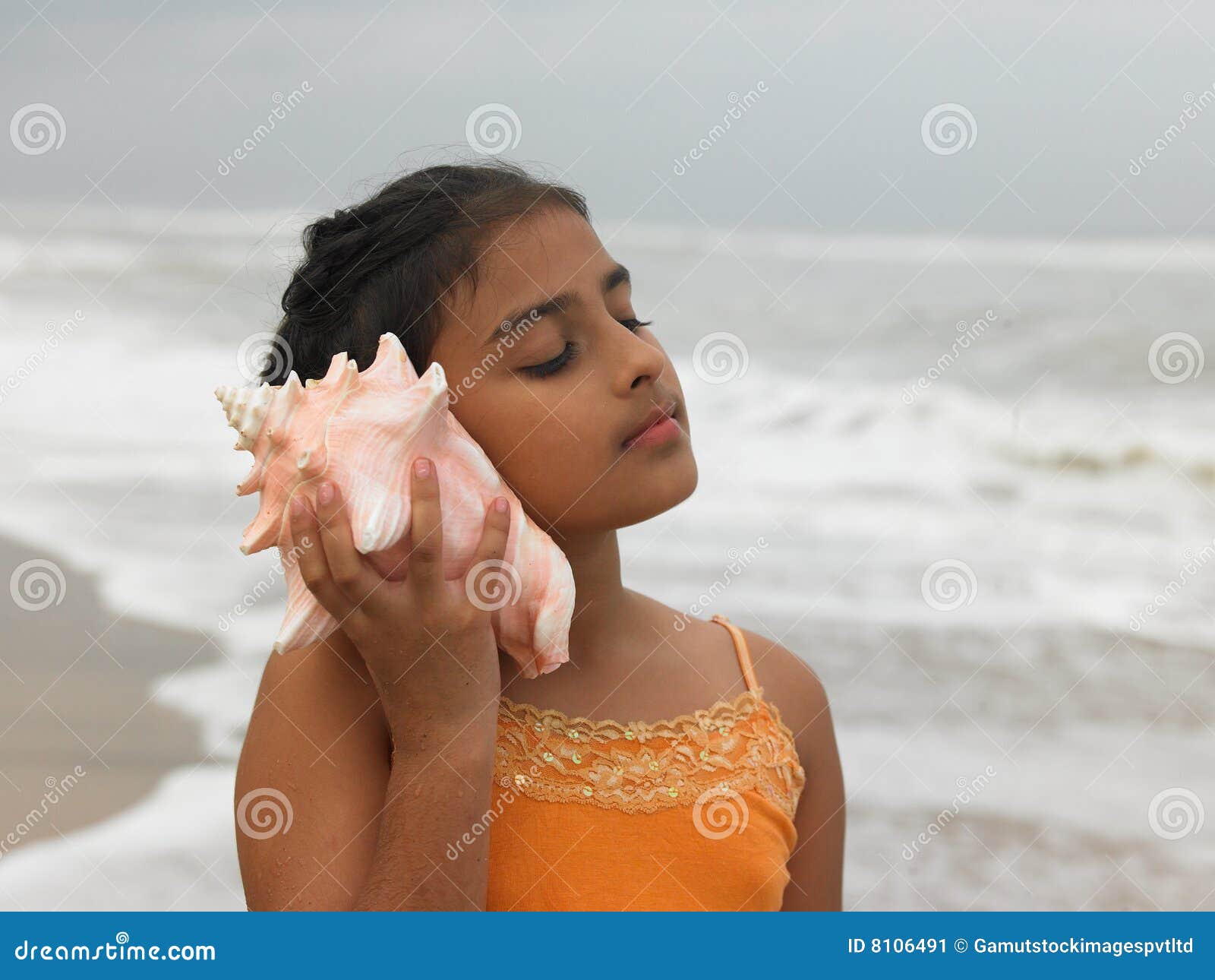 Girl listening to a conch stock image. Image of bare, belief - 8106491