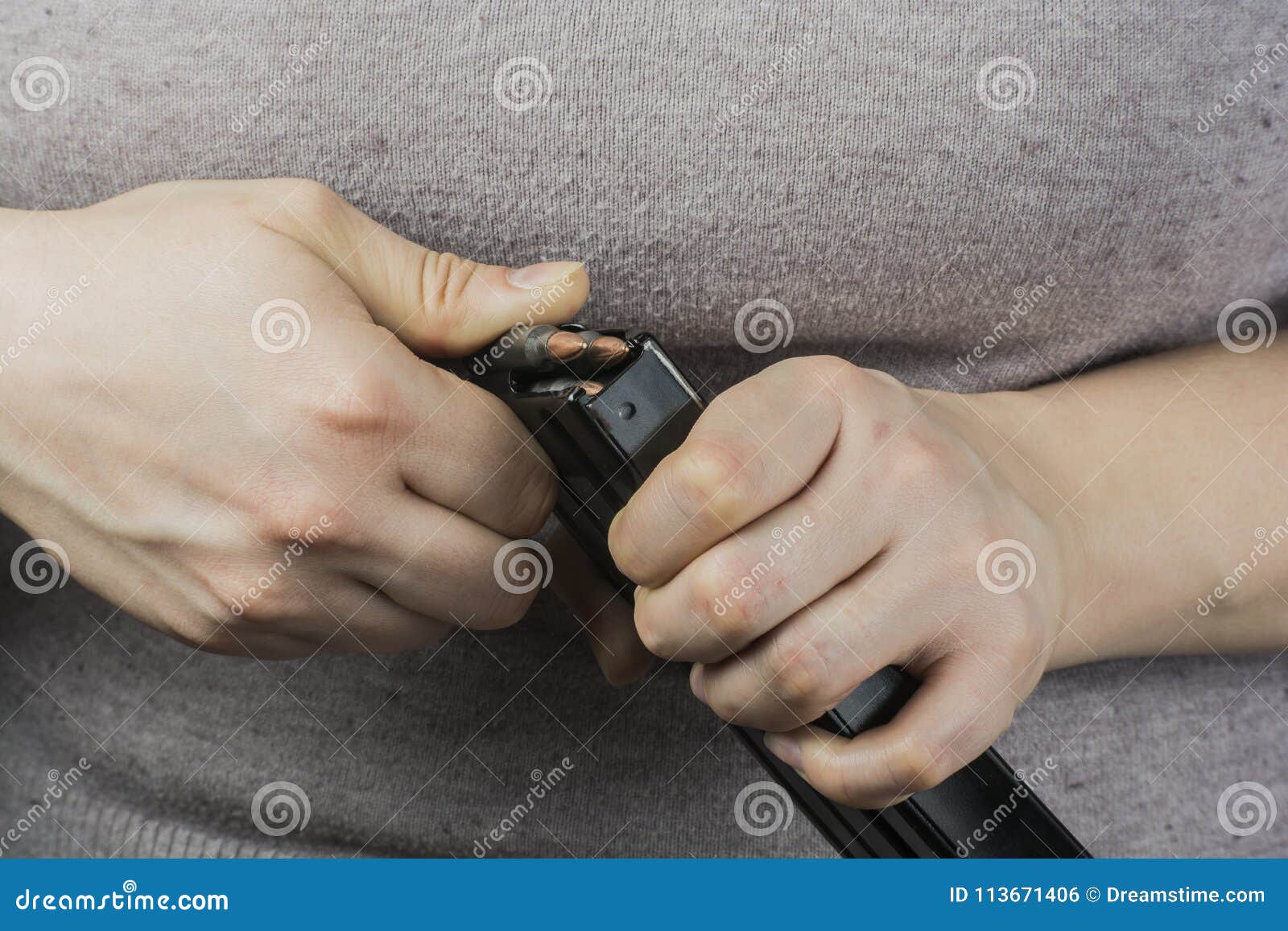 Girl loading cartridges stock photo. Image of cartridge - 113671406