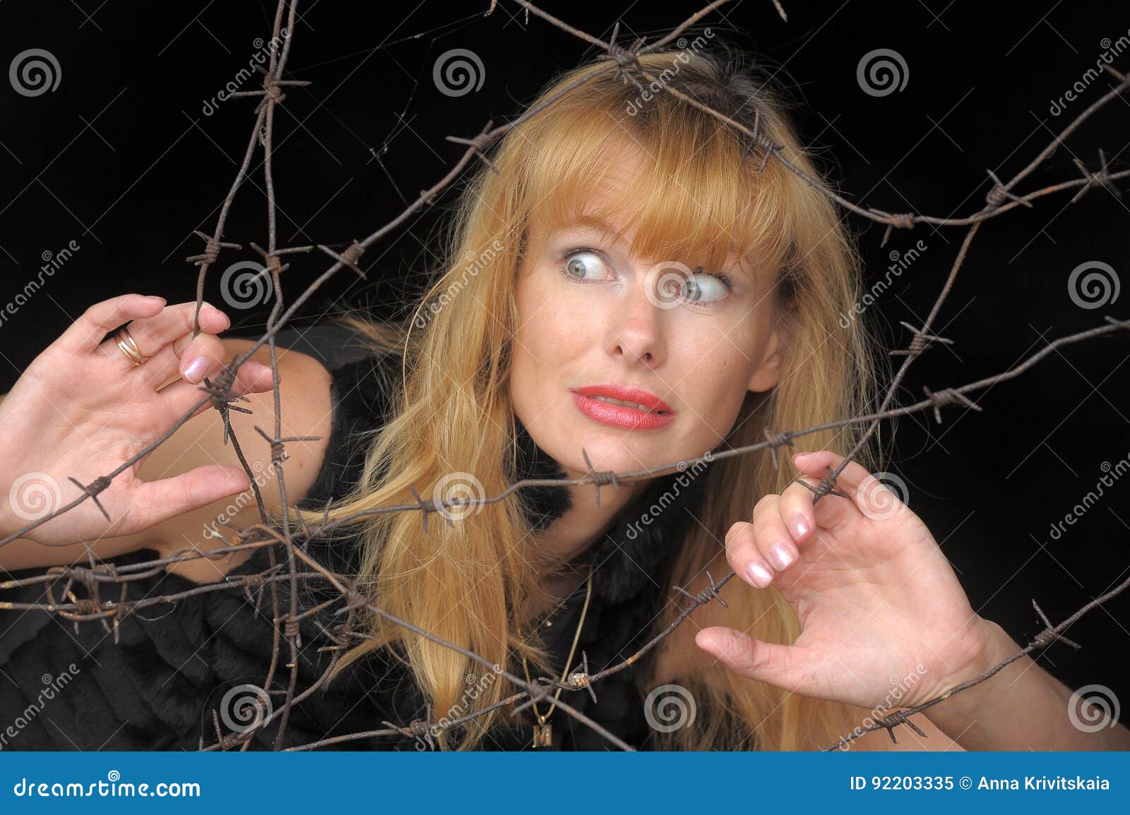 Girl Looking through Barbed Wire Stock Image - Image of beige, blonde ...