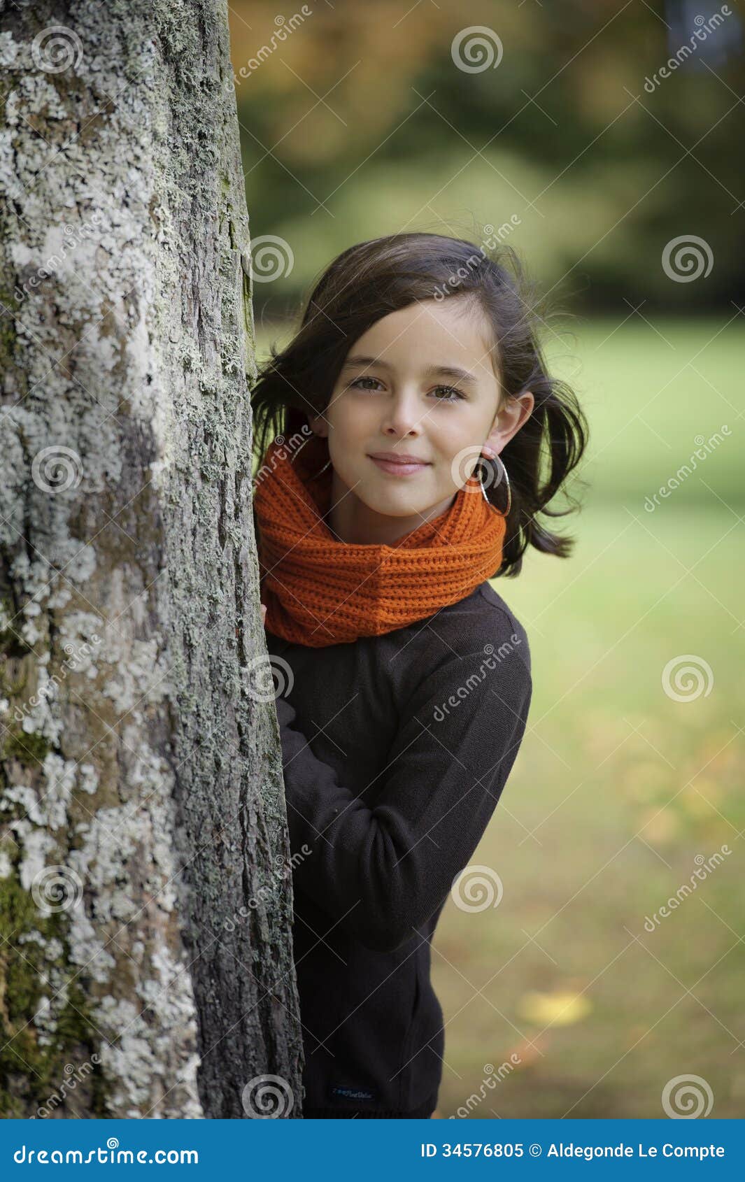 Girl Looking from Behind a Tree Stock Image - Image of fall, beauty ...