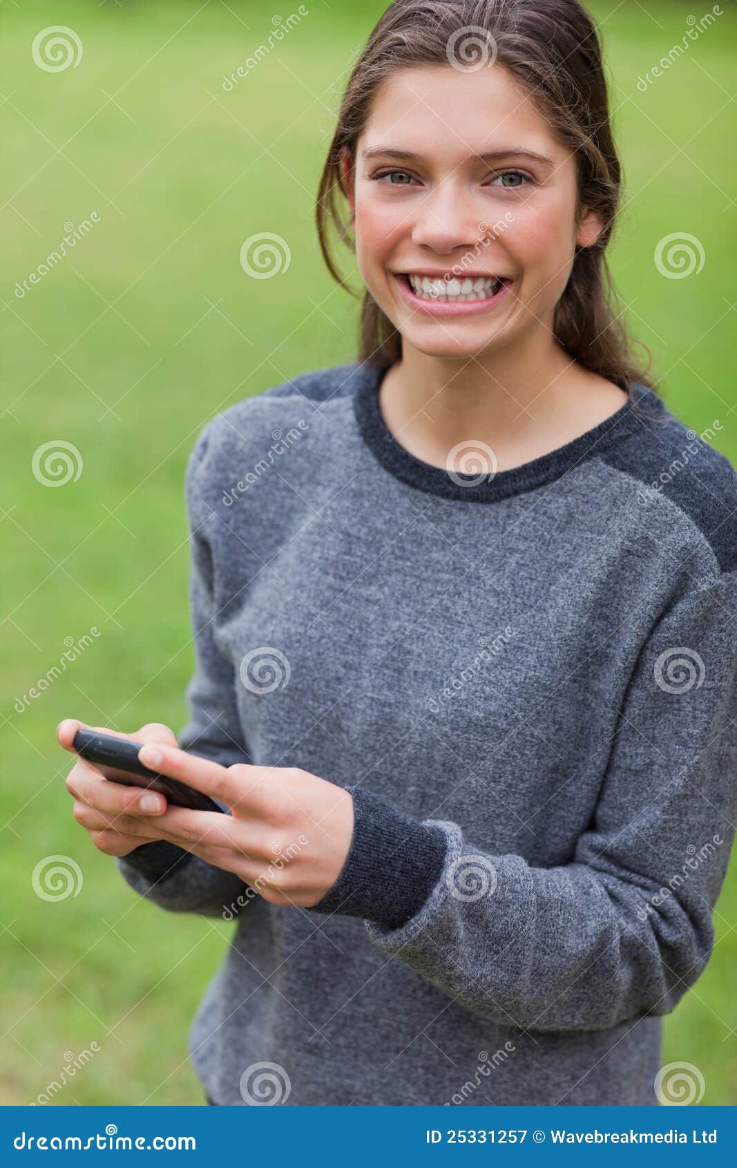 Girl Looking at the Camera while Using Her Mobile Stock Image - Image ...