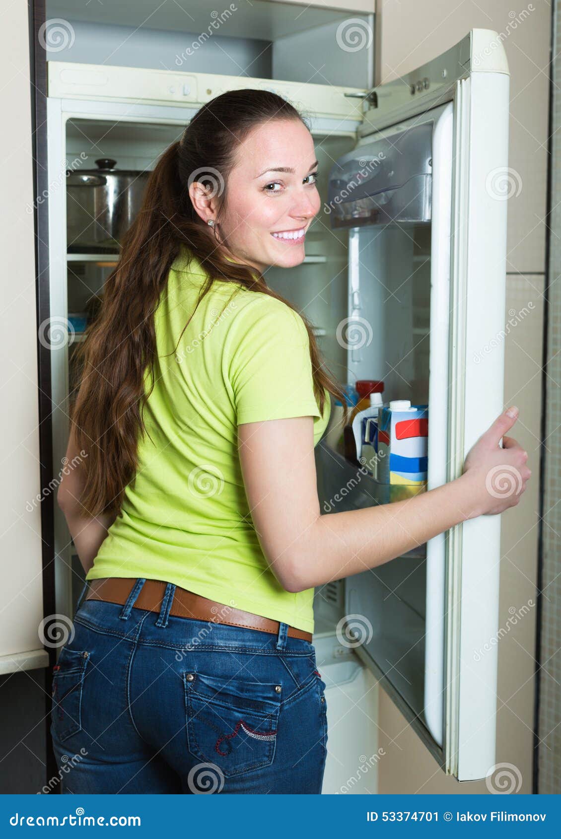 Girl looking in fridge stock image. Image of culinary - 53374701