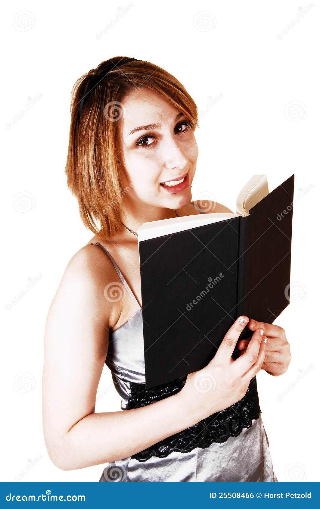 Girl looking over book. stock photo. Image of pretty - 25508466