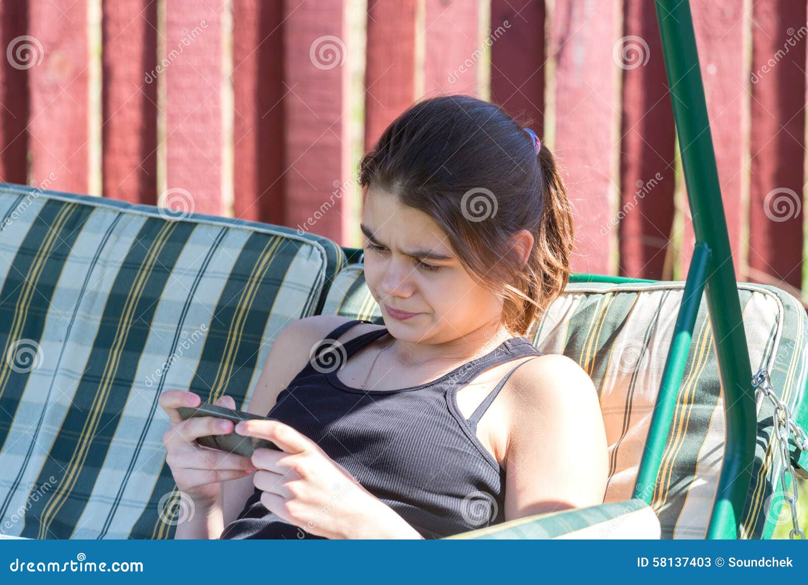 Girl looking at phone stock image. Image of media, female - 58137403