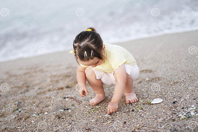 Girl looking for shells stock image. Image of barefoot - 30918809